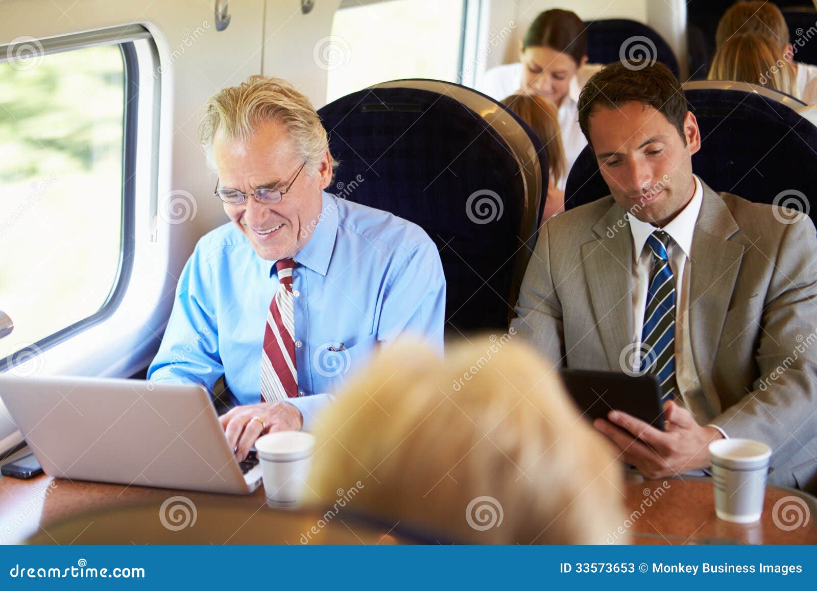 Businessman Commuting To Work on Train and Using Laptop Stock Image ...