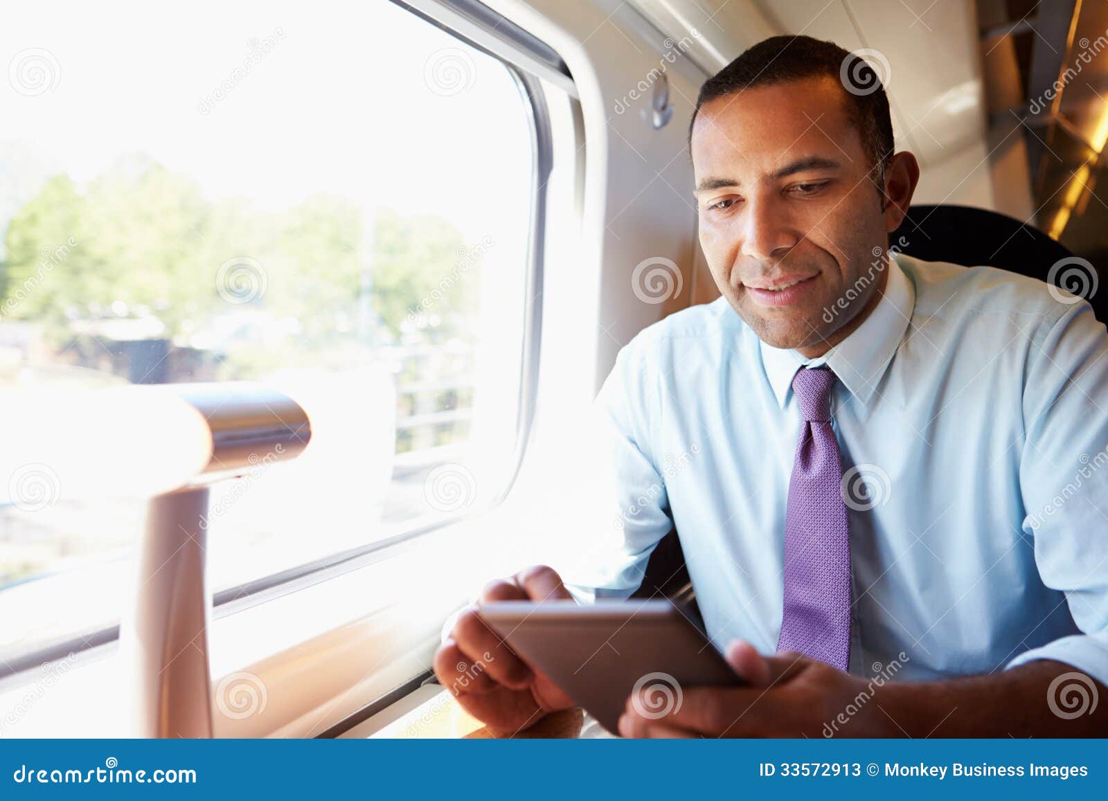 Businessman Commuting on Train Reading a Book Stock Image - Image of ...