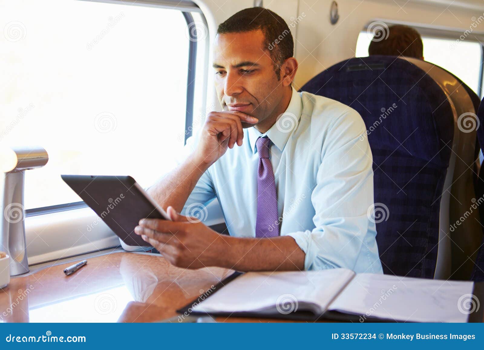 Businessman Commuting on Train Using Digital Tablet Stock Photo - Image ...