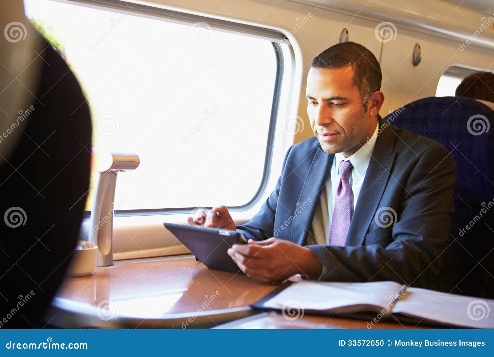 Businessman Commuting on Train Using Digital Tablet Stock Photo - Image ...