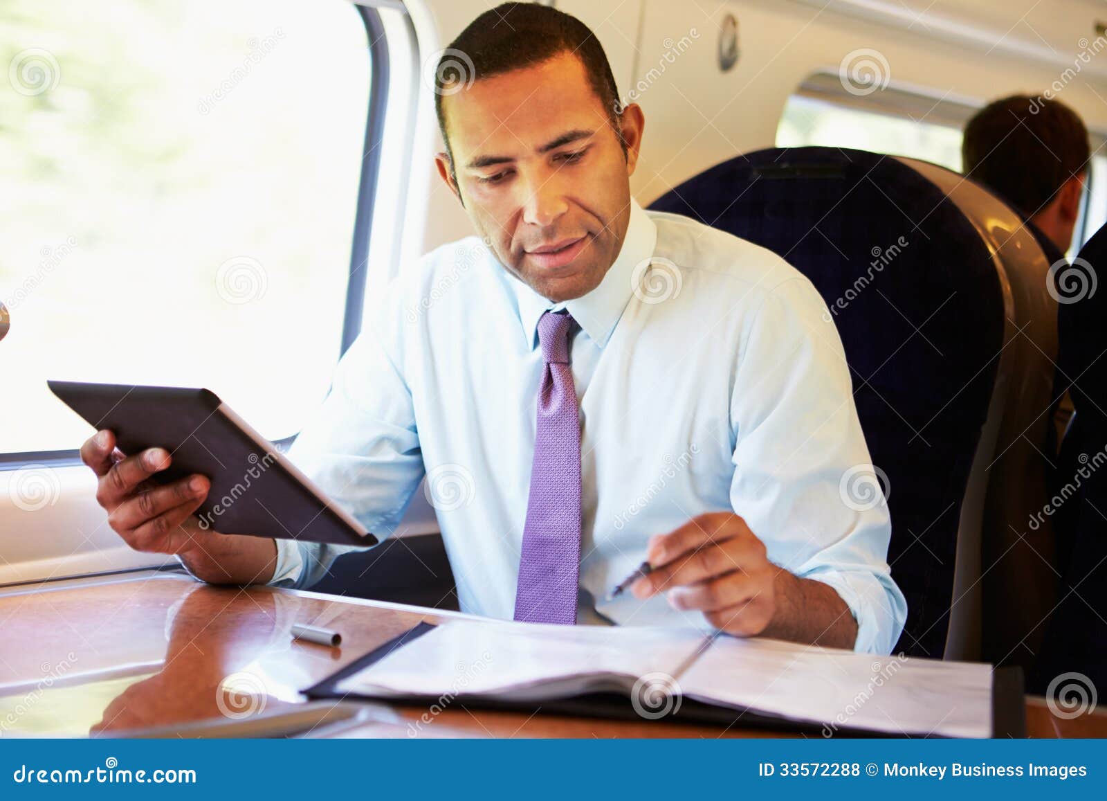 Businessman Commuting on Train Using Digital Tablet Stock Photo - Image ...