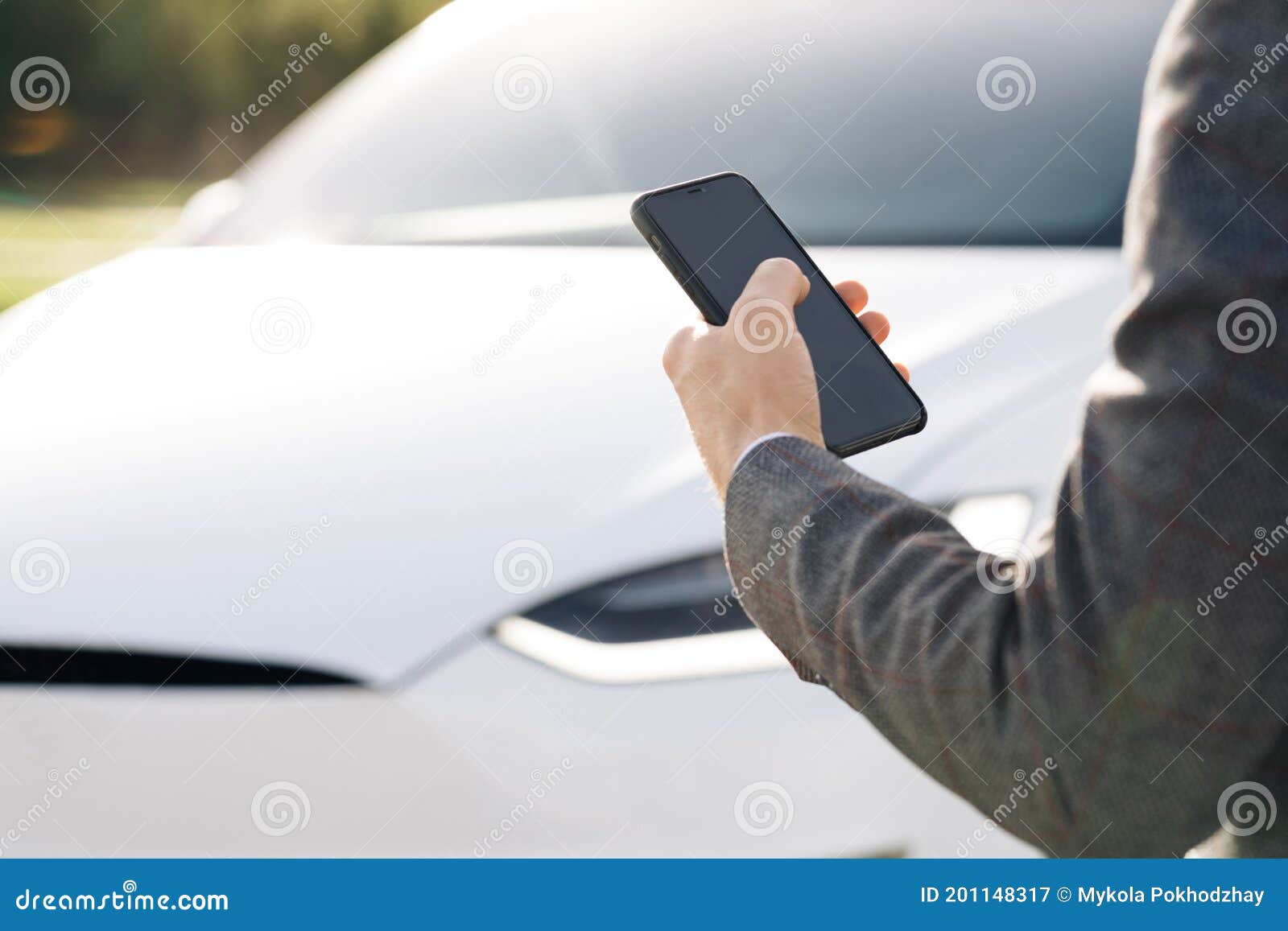 Businessman Controls a Self-driving Electric Car Using Mobile ...