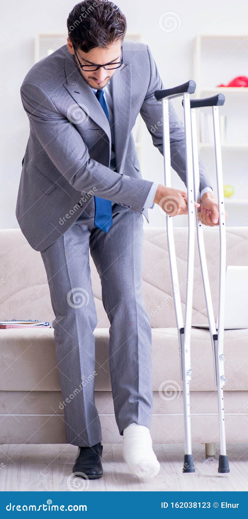 Businessman with Crutches and Broken Leg at Home Working Stock Image ...