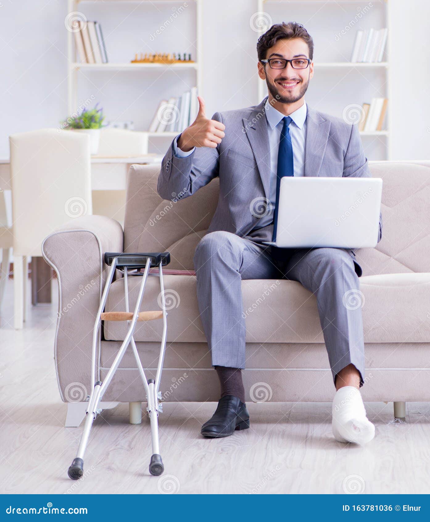Businessman with Crutches and Broken Leg at Home Working Stock Photo ...
