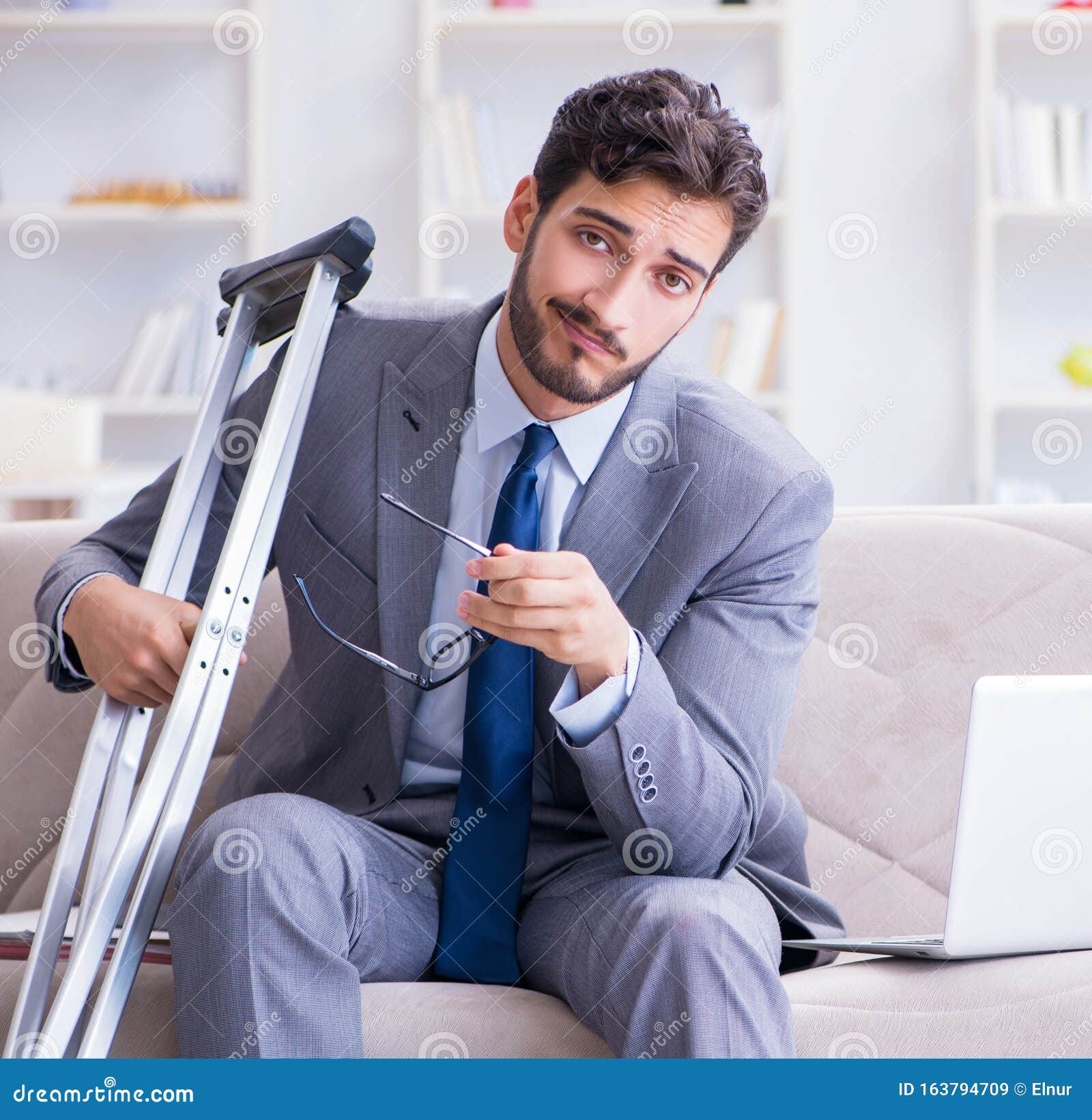 Businessman with Crutches and Broken Leg at Home Working Stock Image ...