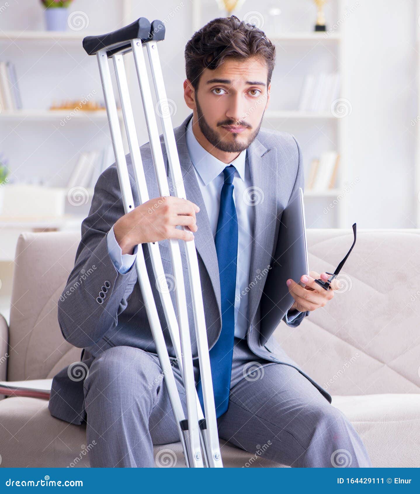 Businessman with Crutches and Broken Leg at Home Working Stock Image ...