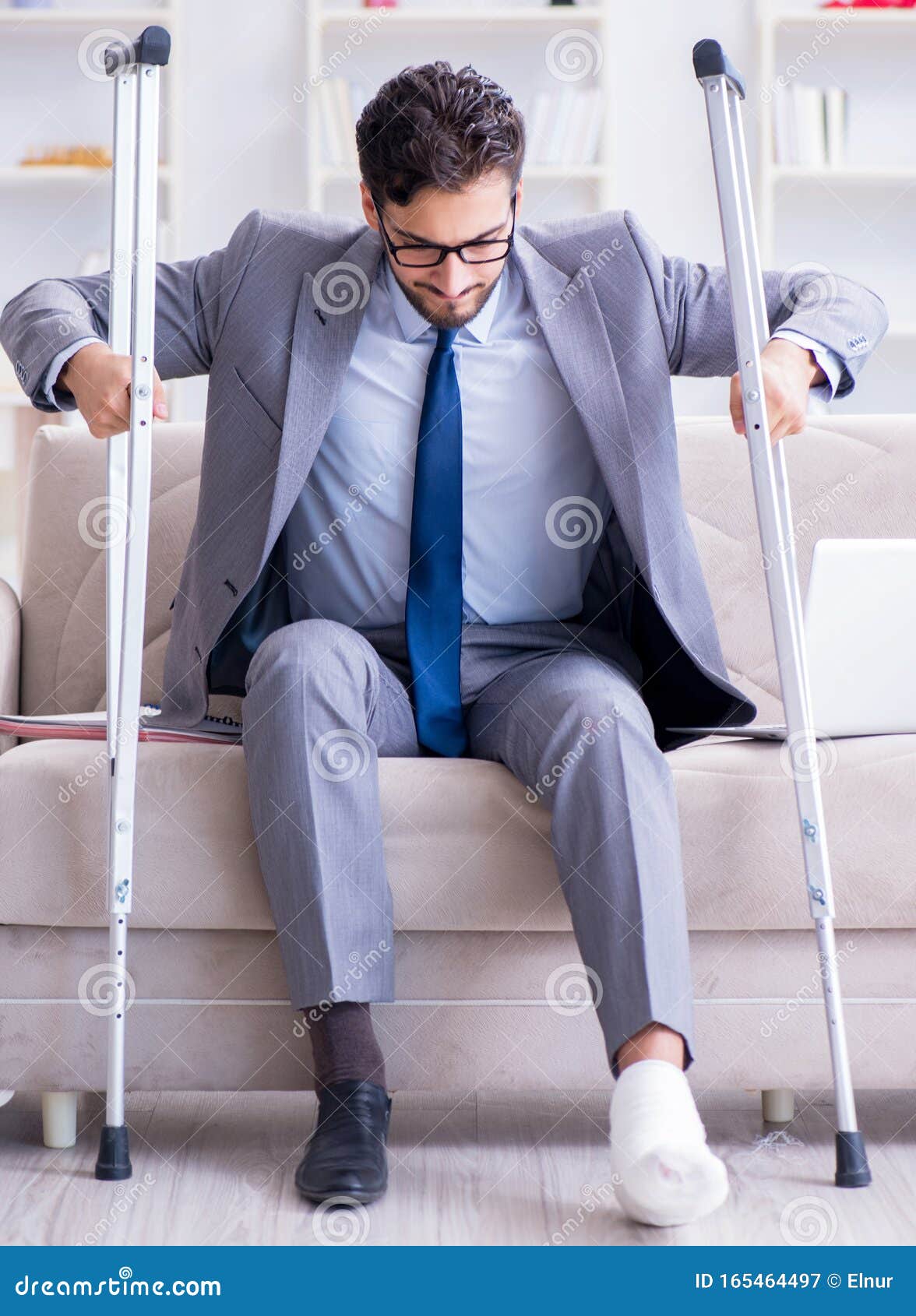 Businessman with Crutches and Broken Leg at Home Working Stock Image ...