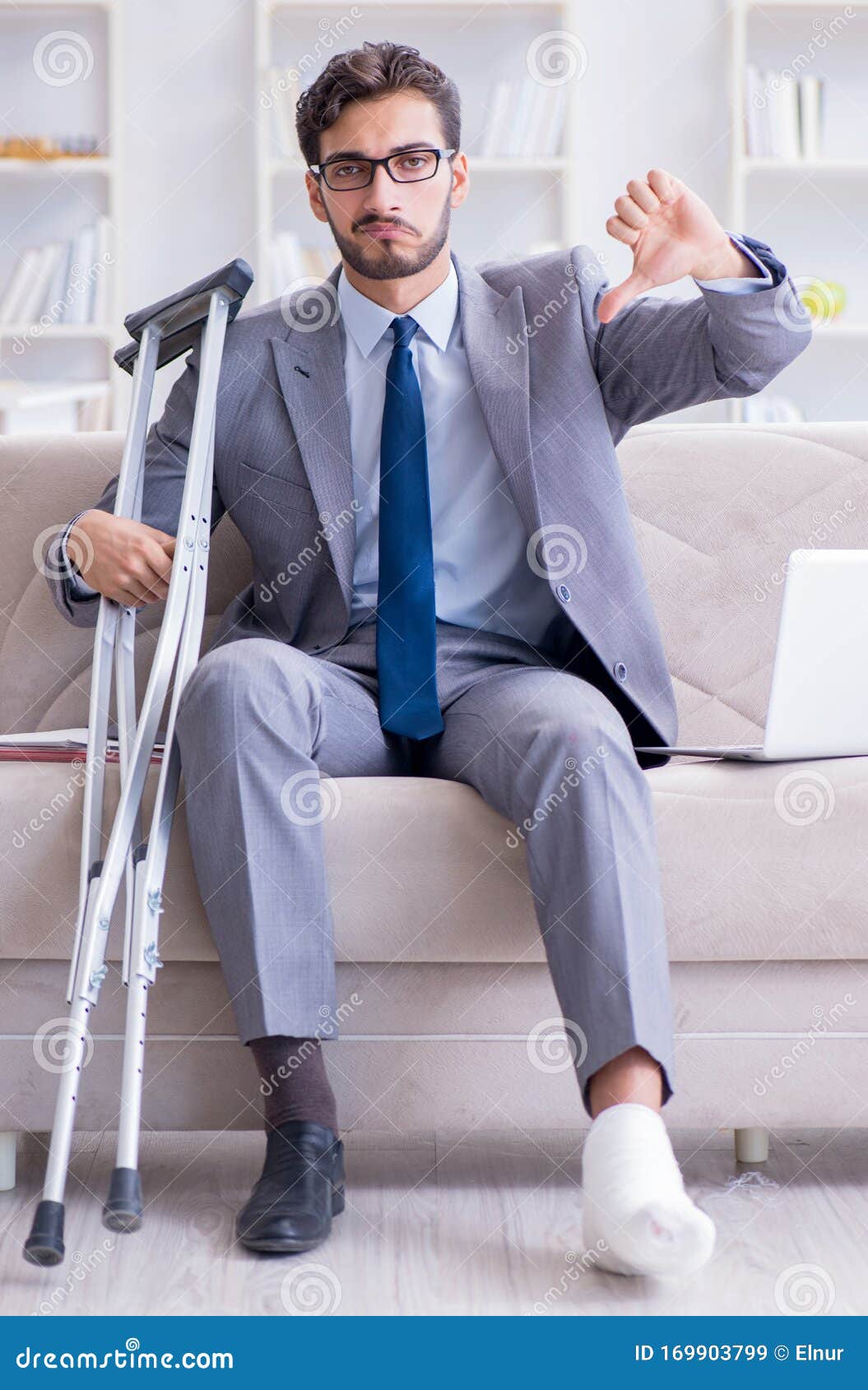 Businessman with Crutches and Broken Leg at Home Working Stock Image ...