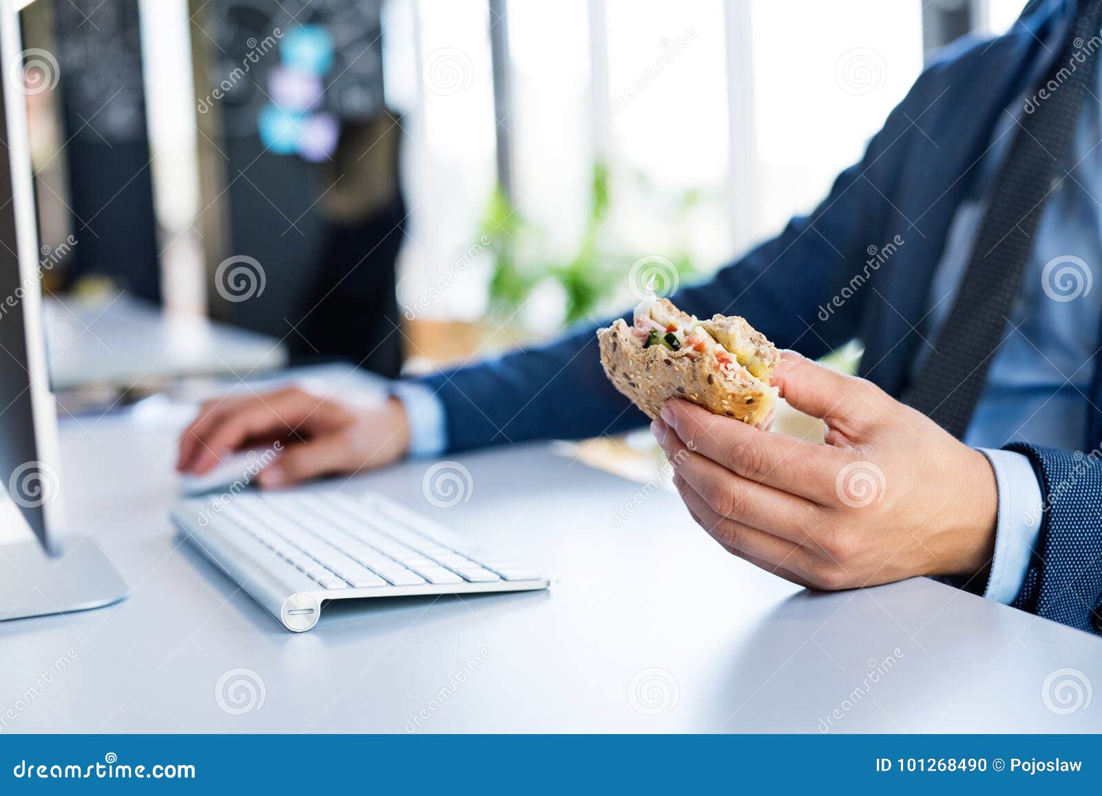 Businessman at the Desk with Computer Eating Lunch. Stock Photo - Image ...
