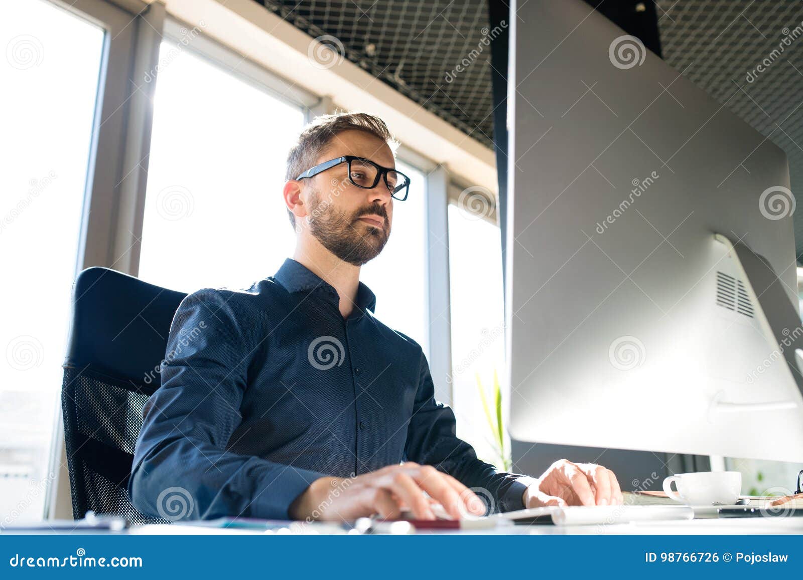 Businessman at the Desk with Computer in His Office. Stock Photo ...