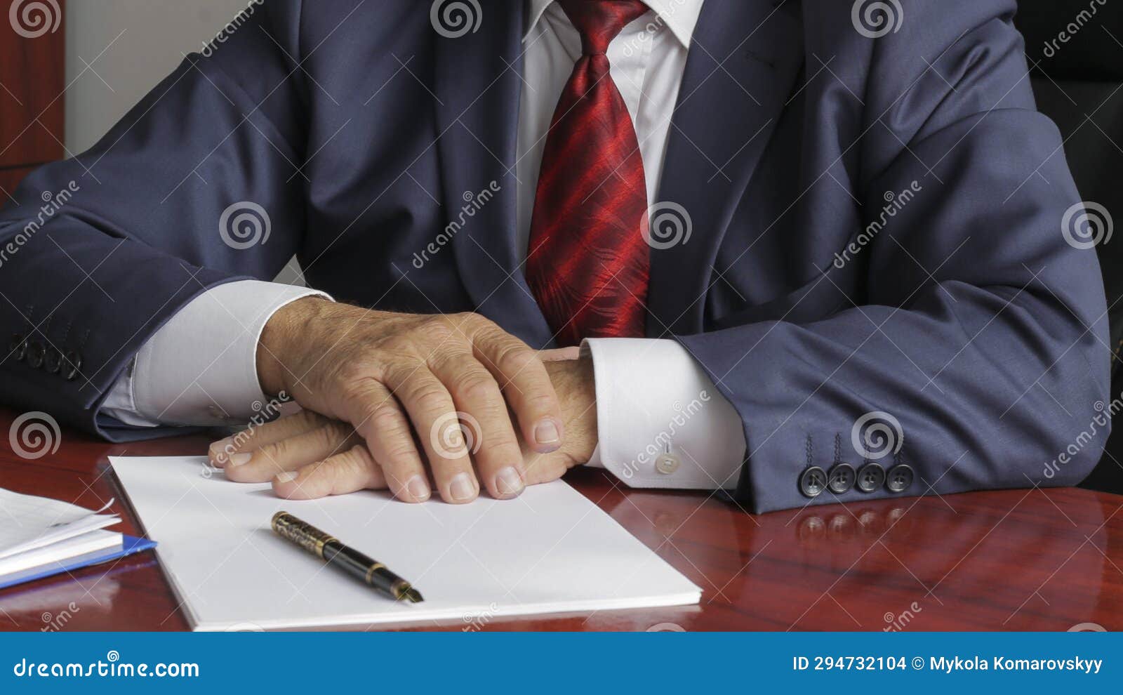 Businessman at Desk with Hands Folded Stock Photo - Image of document ...