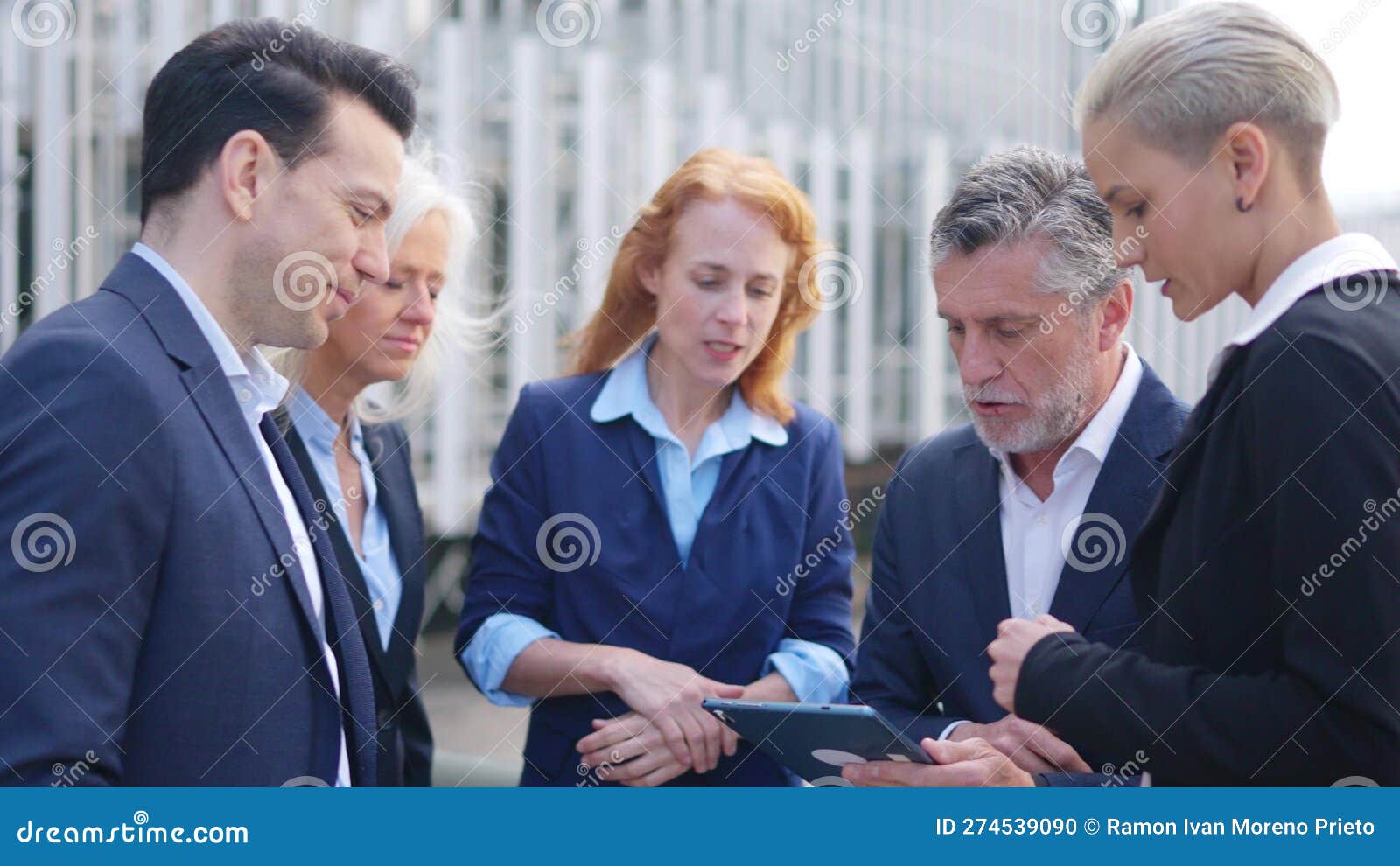 Businessman Dividing Tasks among His Employees while Using a Tablet ...