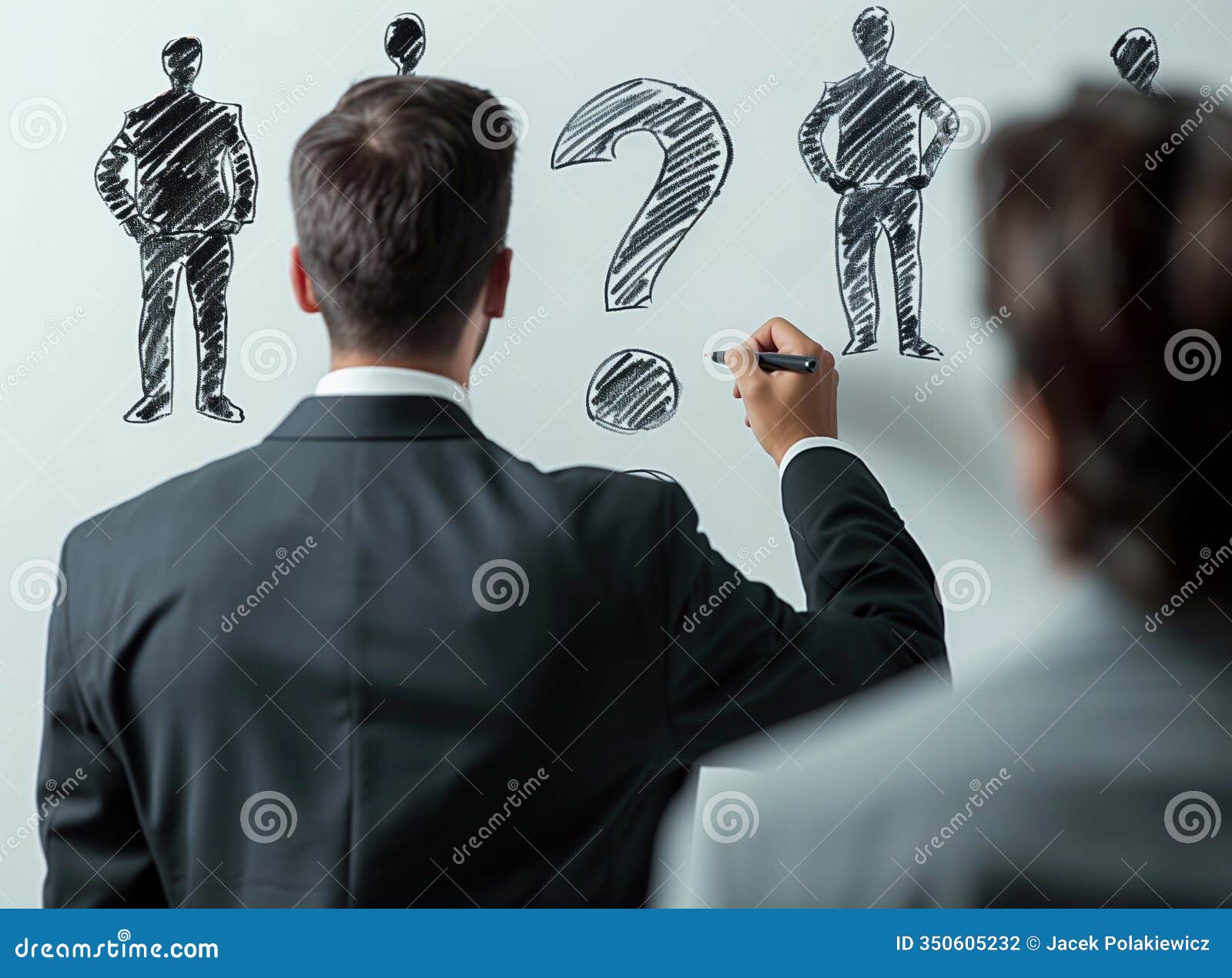 A Businessman Draws Question Mark and Human Silhouettes on a Whiteboard ...