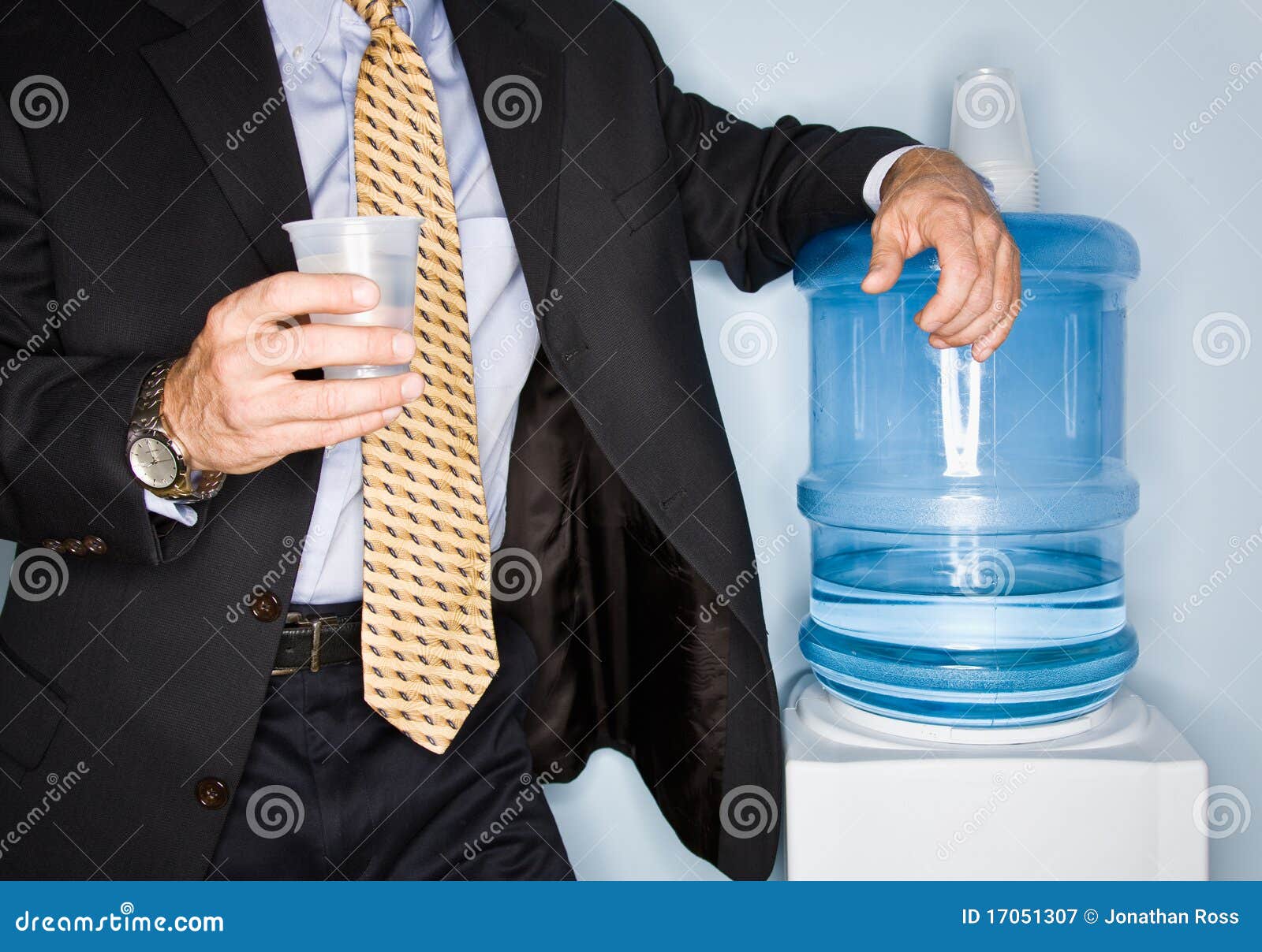 Businessman Drinking Water from Water Cooler Stock Image - Image of ...