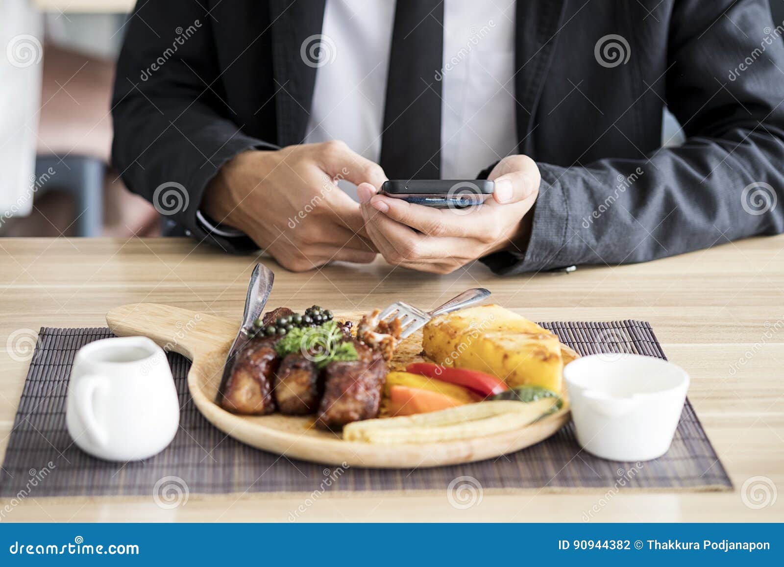 Businessman are Eating and Using Smartphone. Stock Photo - Image of ...