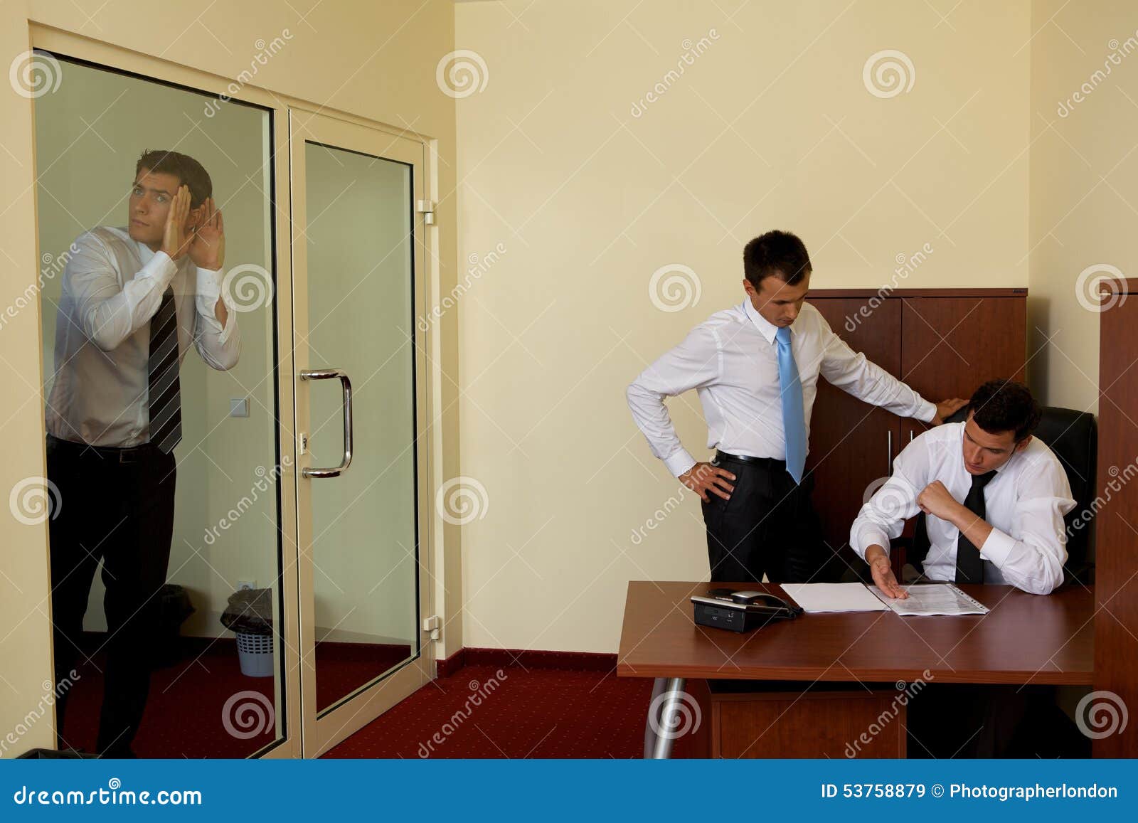Businessman Eavesdropping on Conversation between Colleagues in Office ...