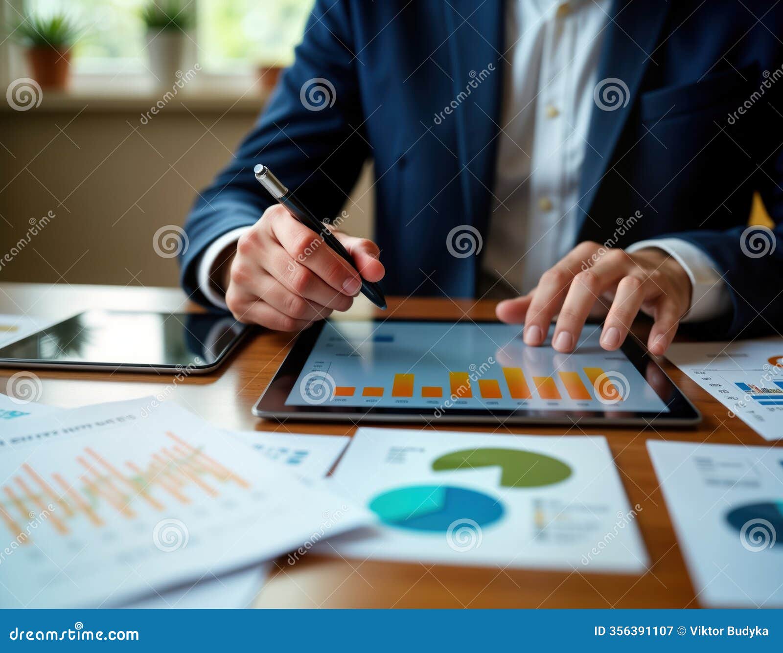 Businessman Examines Eco Growth Charts on Tablet. Strategic Planning in ...