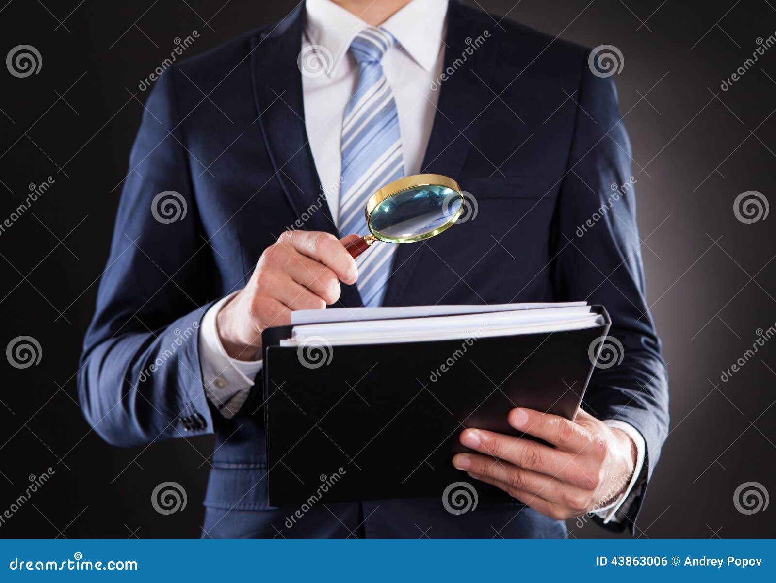Businessman Examining Documents with Magnifying Glass Stock Photo ...