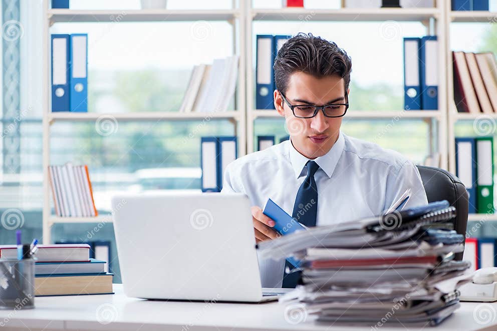 The Businessman with Excessive Work Paperwork Working in Office Stock ...