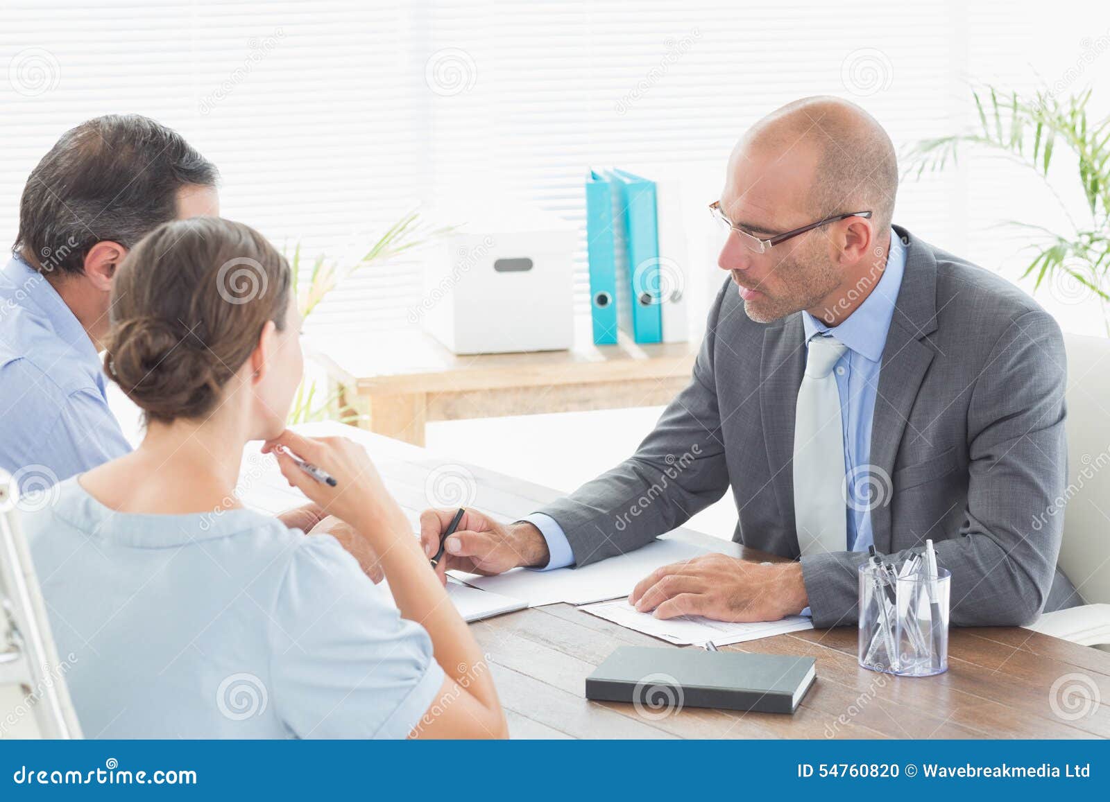 Businessman Explaining Contract To Business Partners Stock Photo ...