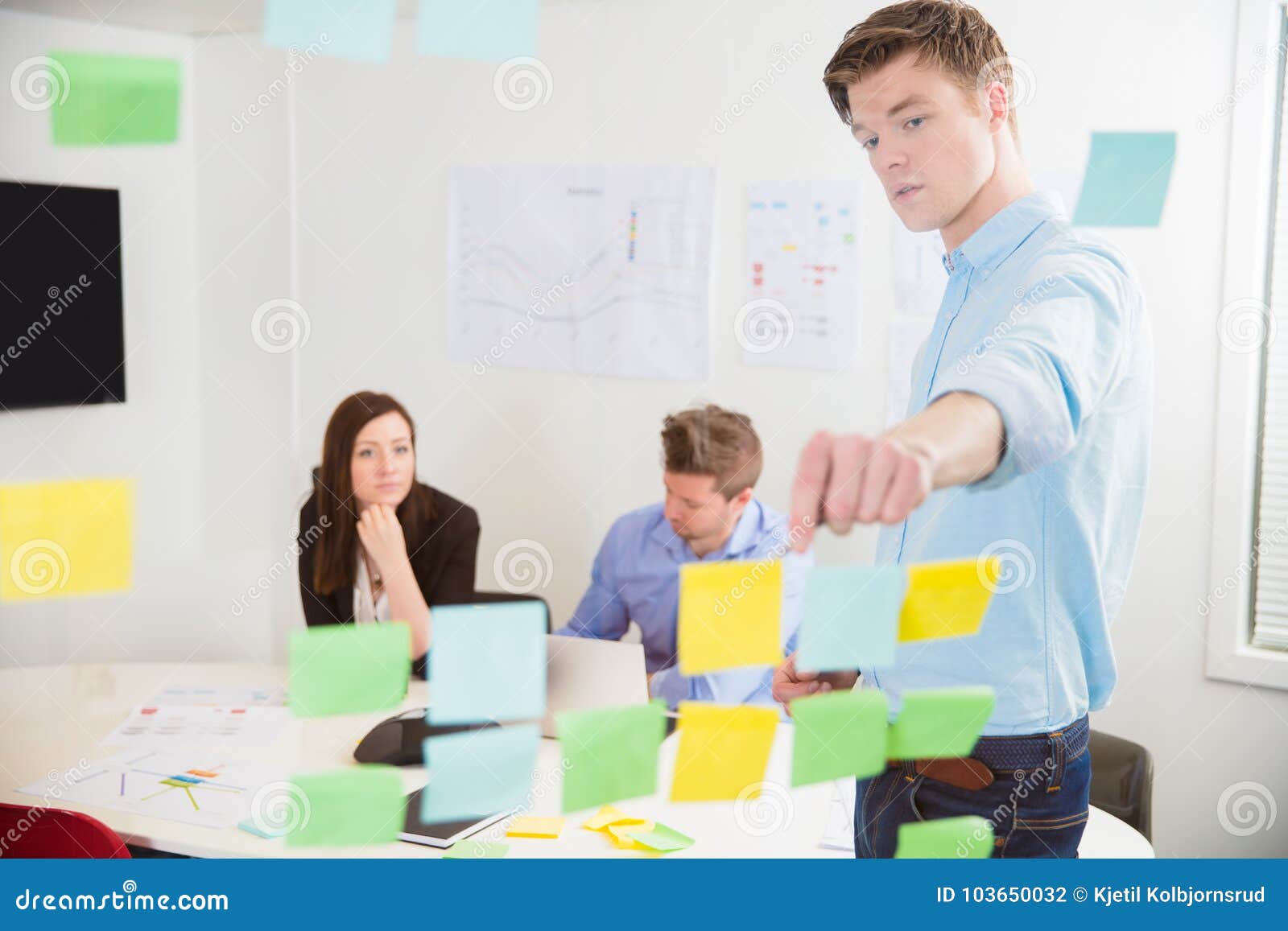 Businessman Explaining Notes To Colleagues in Office Stock Photo ...