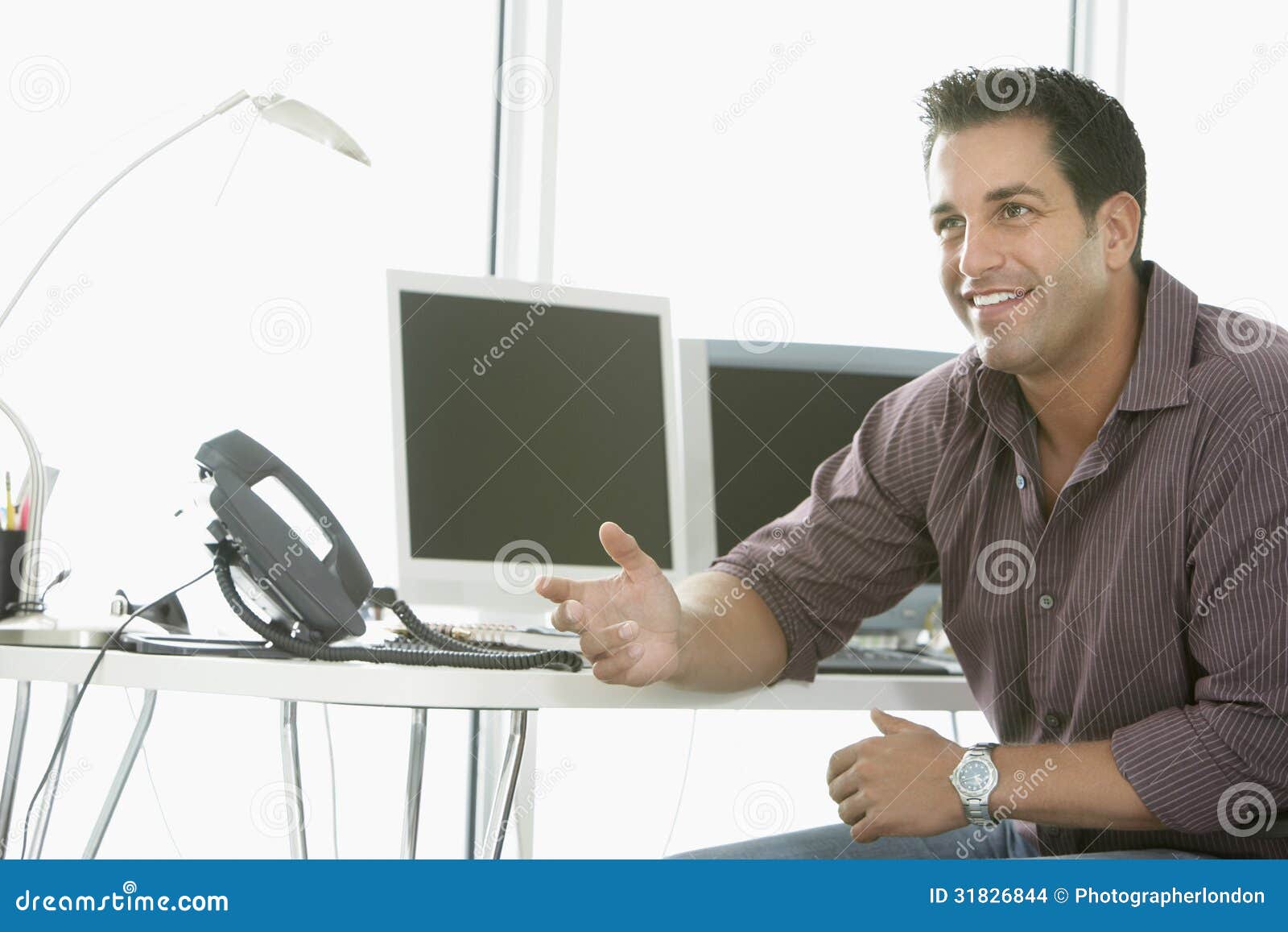 Businessman Explaining while Sitting by Office Desk Stock Photo - Image ...