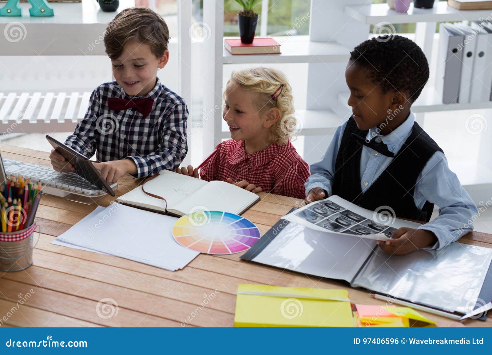 Businessman Explaining To Colleagues Over Tablet in Office Stock Photo ...