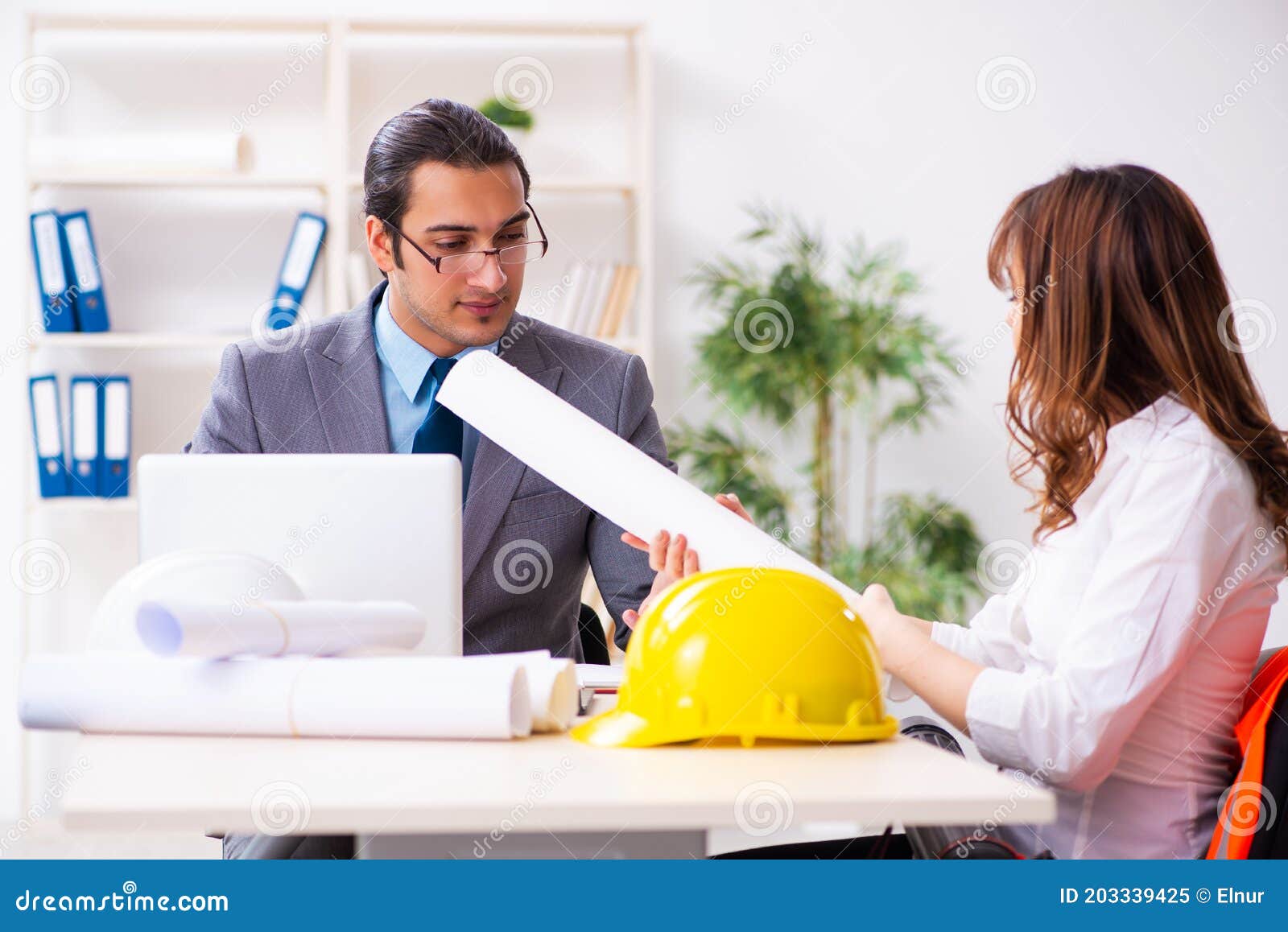 Young Businessman and Female Architect Discussing New Project Stock ...