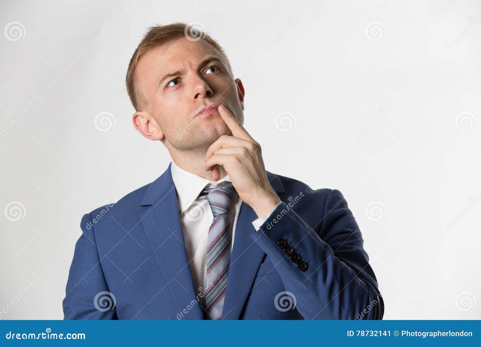 Businessman with Finger on Face Thinking Stock Image - Image of ...