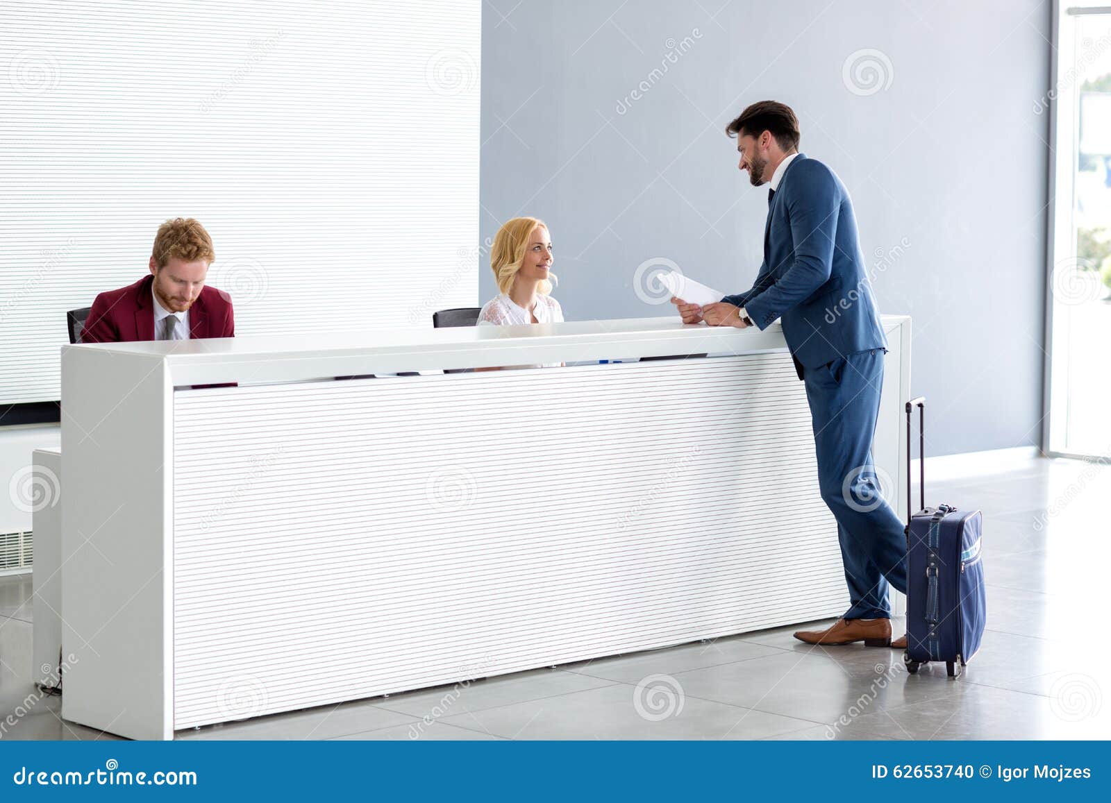 Businessman Flirting at Reception with Female Receptionist Stock Photo ...