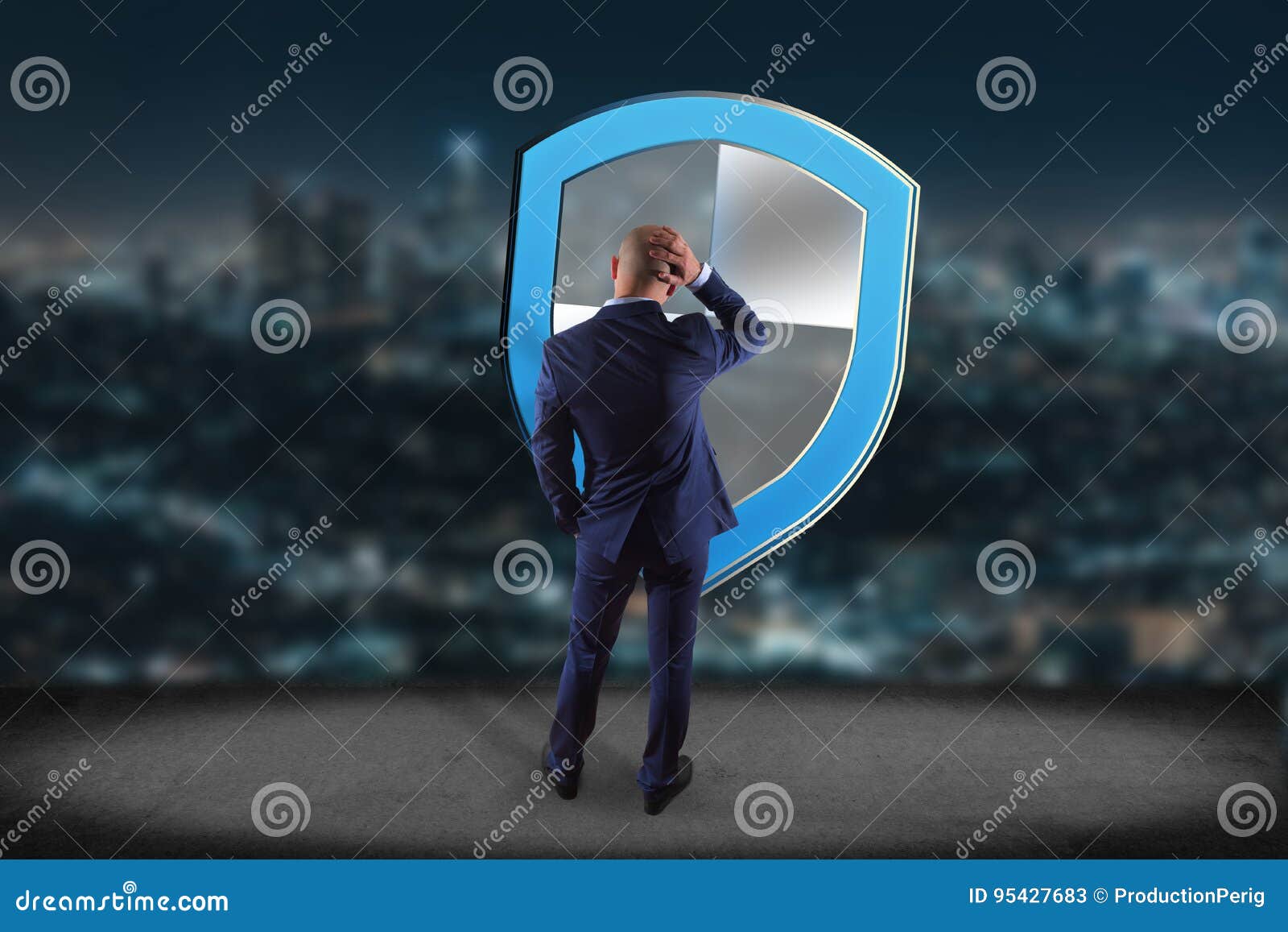 Businessman in Front of a Wall with a Shield Symbol Displayed on Stock ...