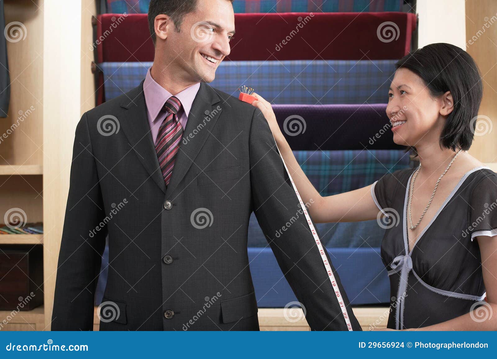 Businessman Getting Measured by Female Tailor Stock Photo - Image of ...