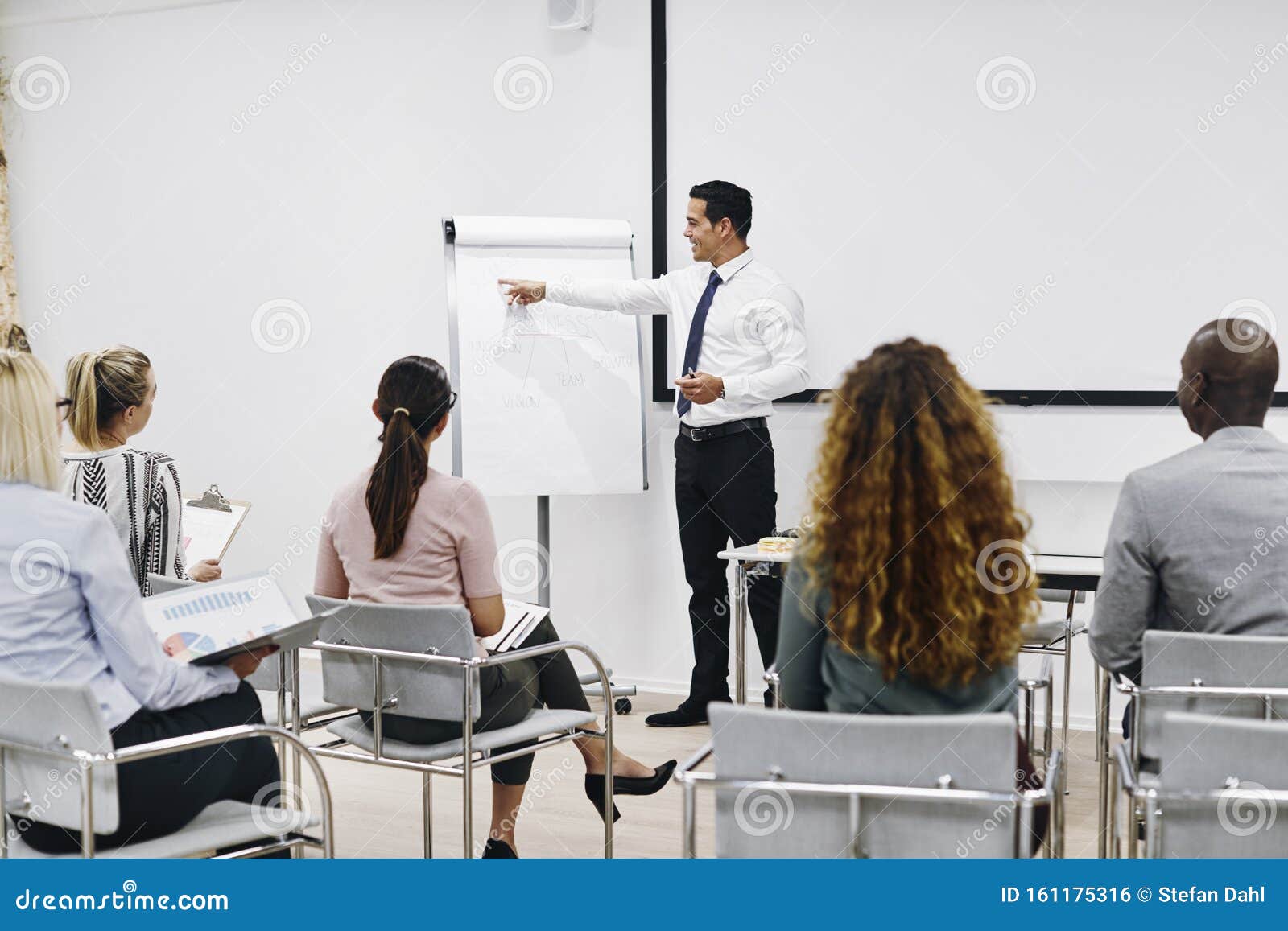 Businessman Giving a Presentation To Staff in an Office Stock Photo ... Businessman Giving a Presentation To Staff in an Office Stock Photo ...