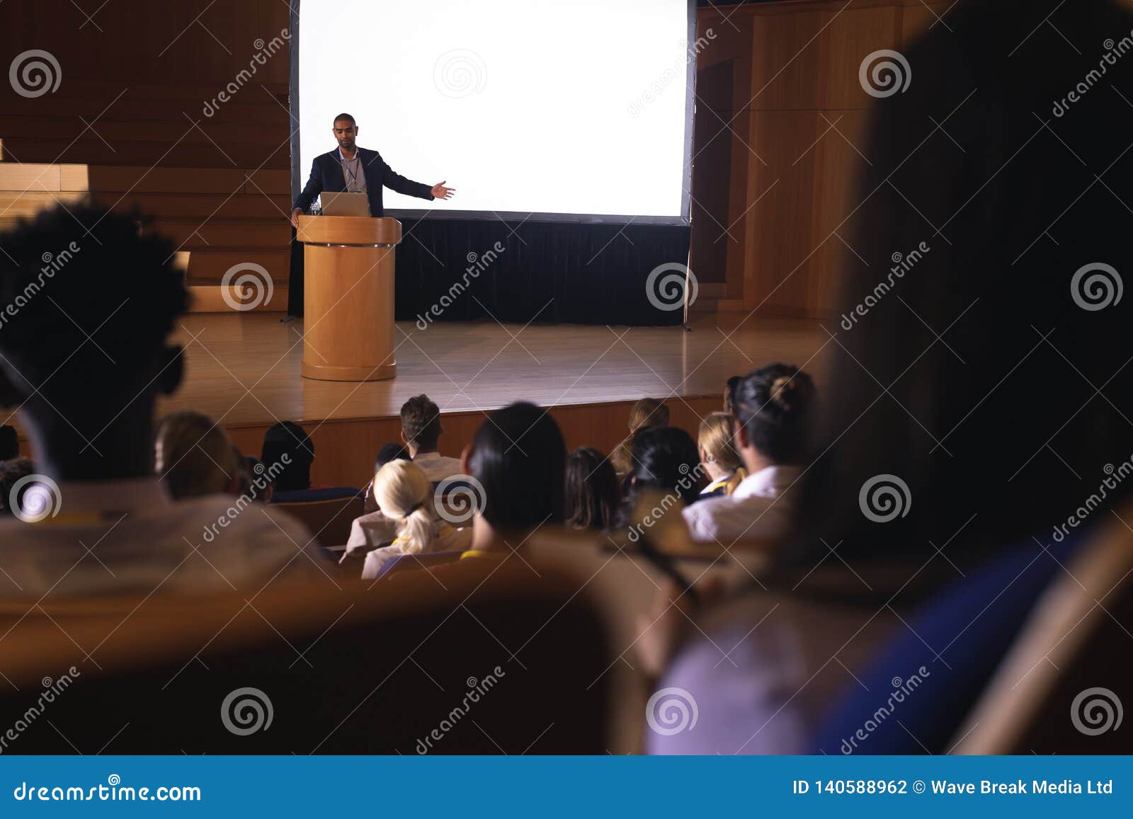 Businessman Giving Presentation on White Projector in Front of the ...