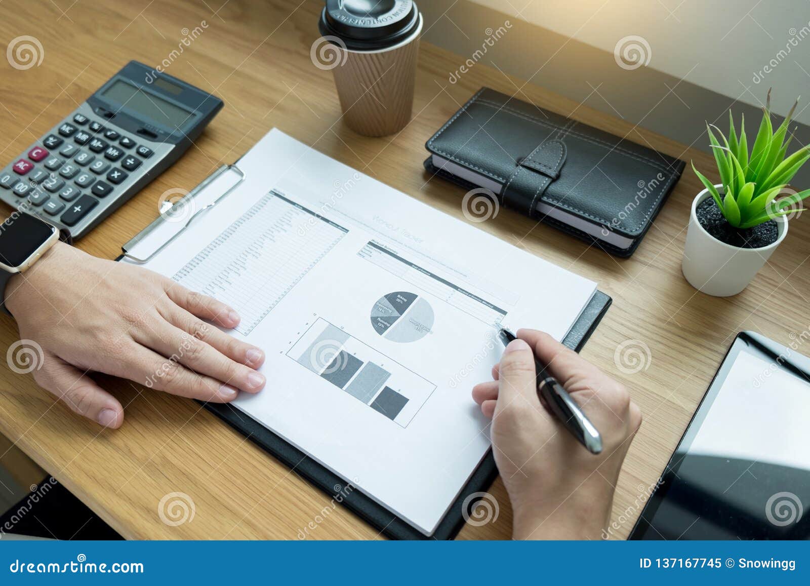 Businessman Going through Some Paperwork and Signing a Document at Desk ...