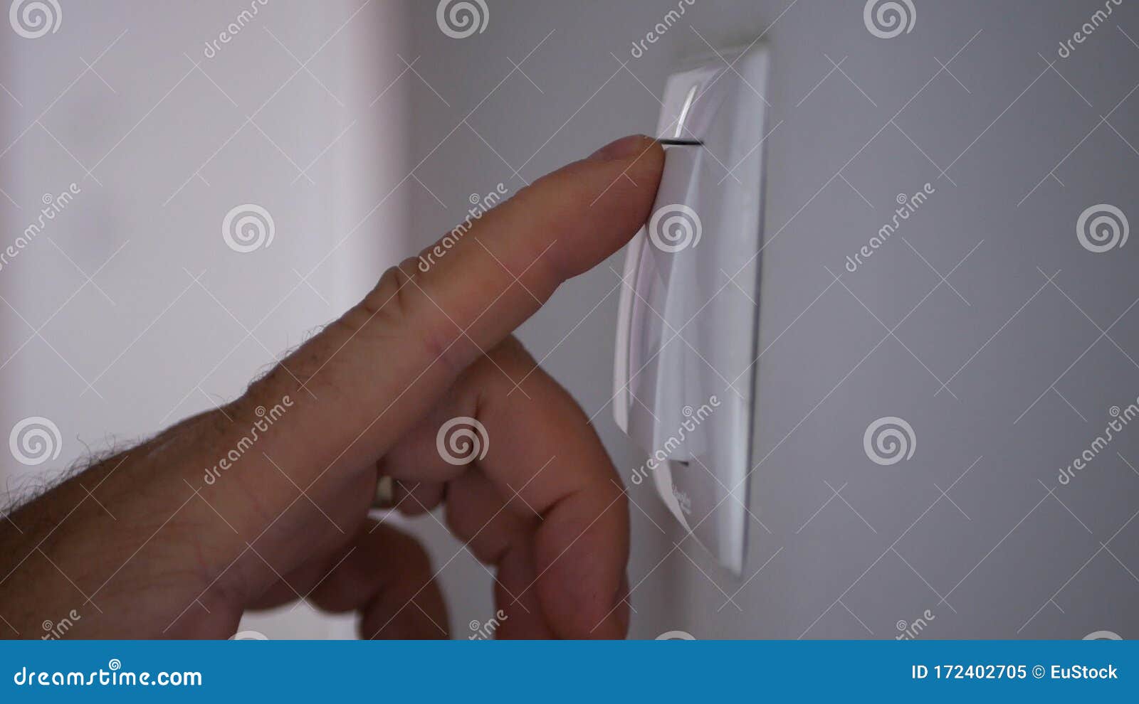 Businessman Hand Pushing on the Light Switch from Office Room Wall ...