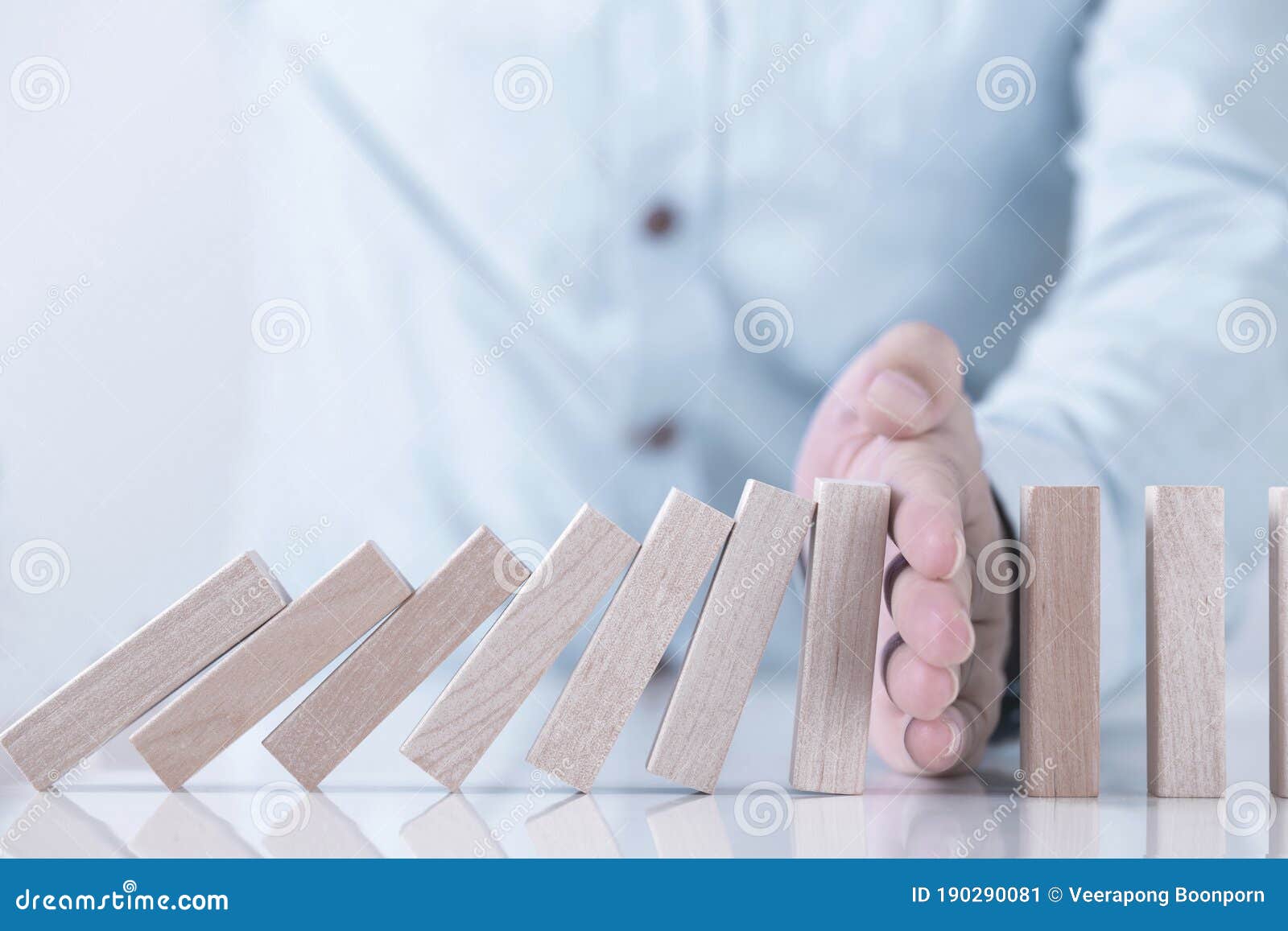 Businessman Hand Stopping the Domino Effect for Management and Solution ...