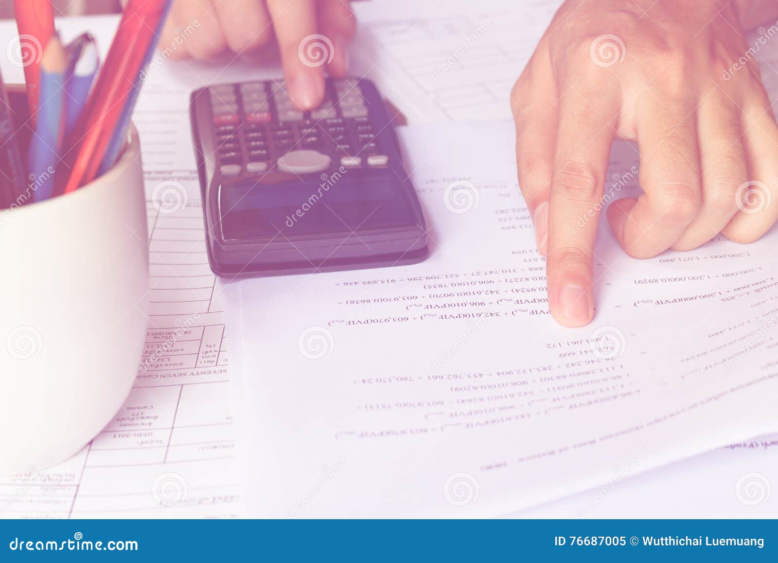 Businessman Hand Using a Calculator To Calculate the Numbers ...