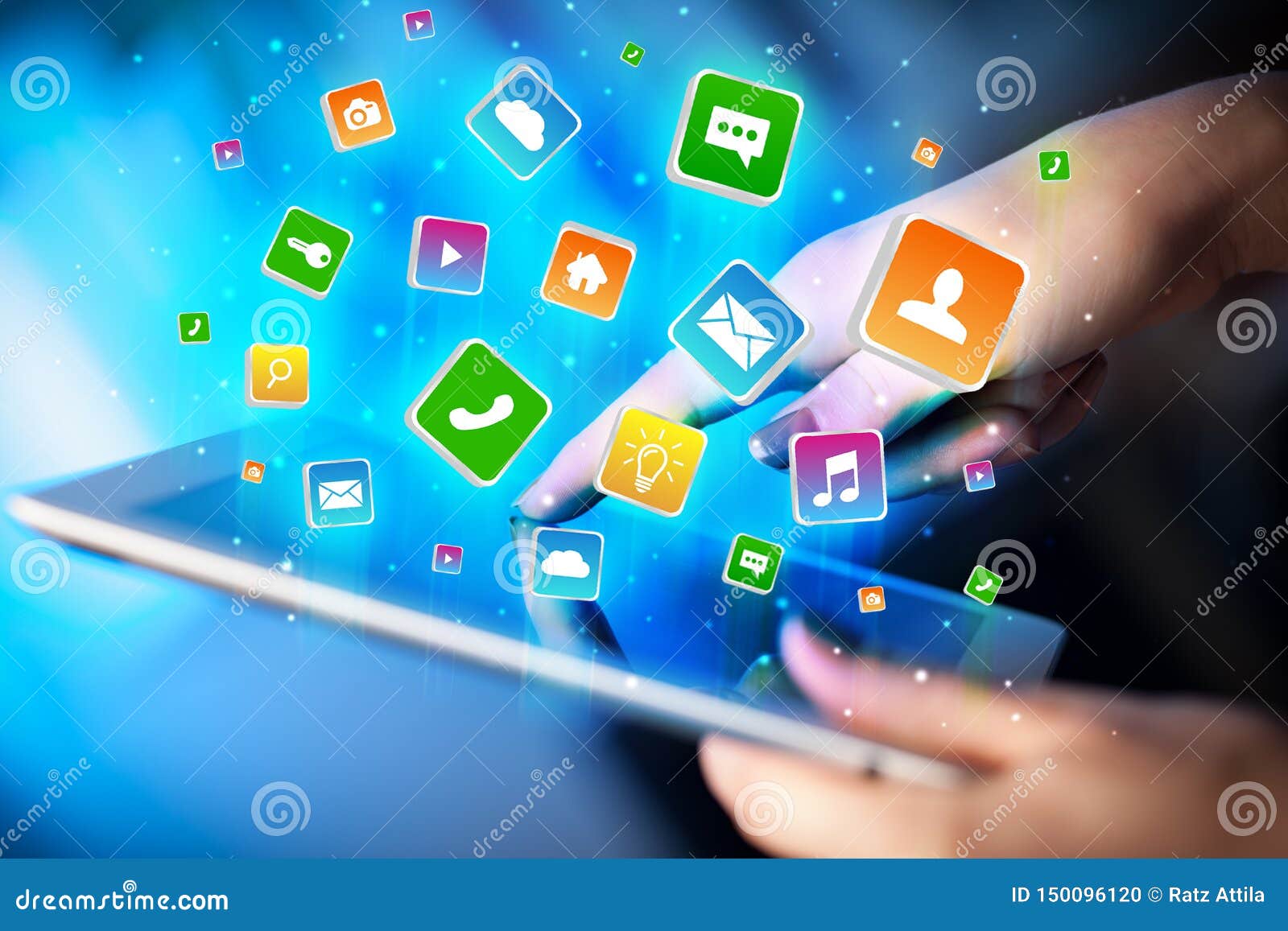 Hand Using Tablet with Application Icons Flying Around Stock Photo ...