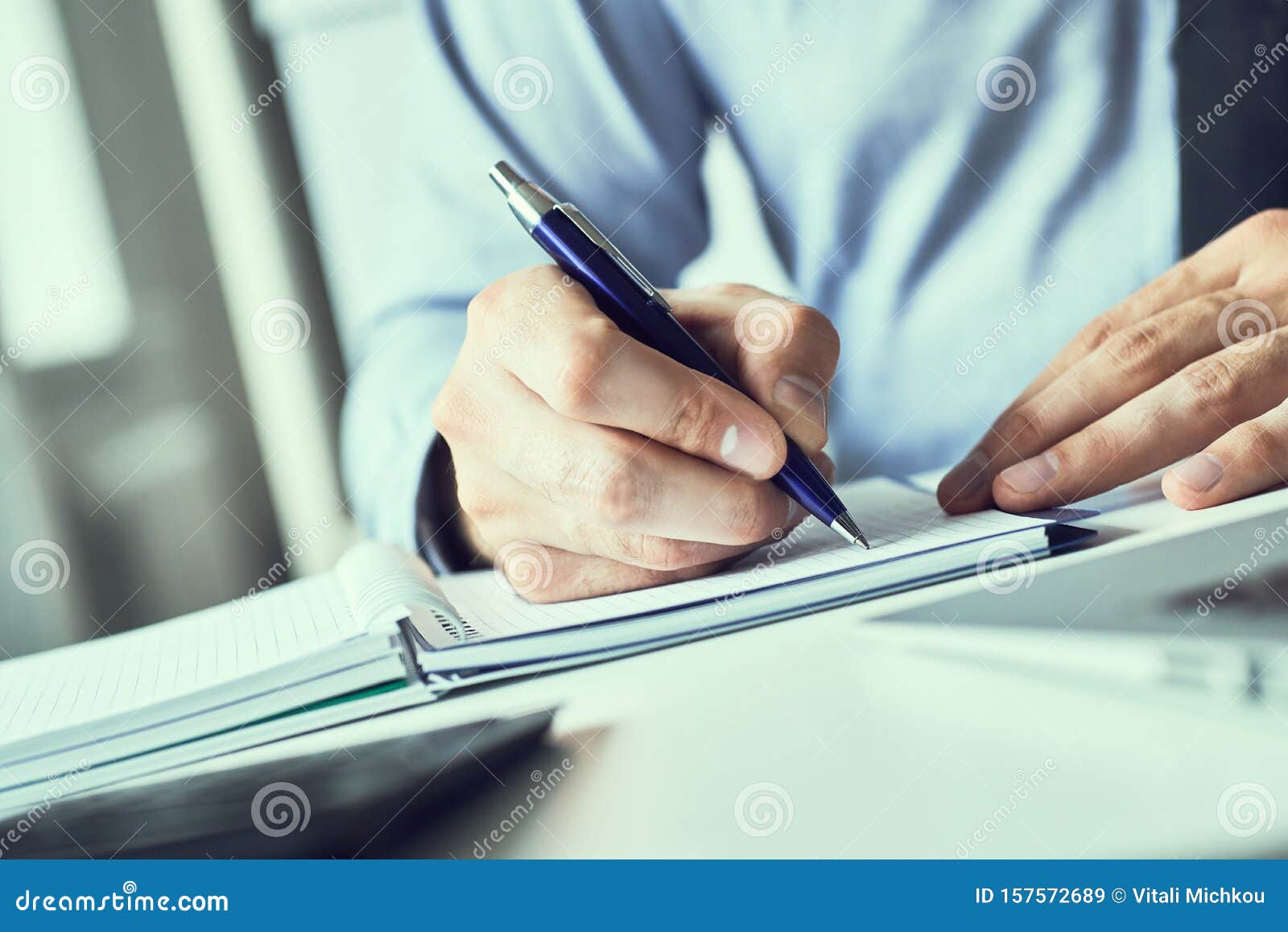 Businessman Hand Writing Note on a Notebook. Business Man Working at ...