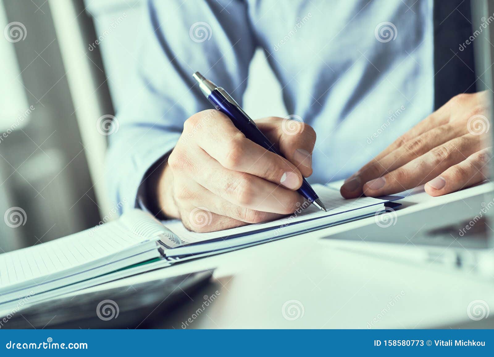 Businessman Hand Writing Note on a Notebook. Business Man Working at ...