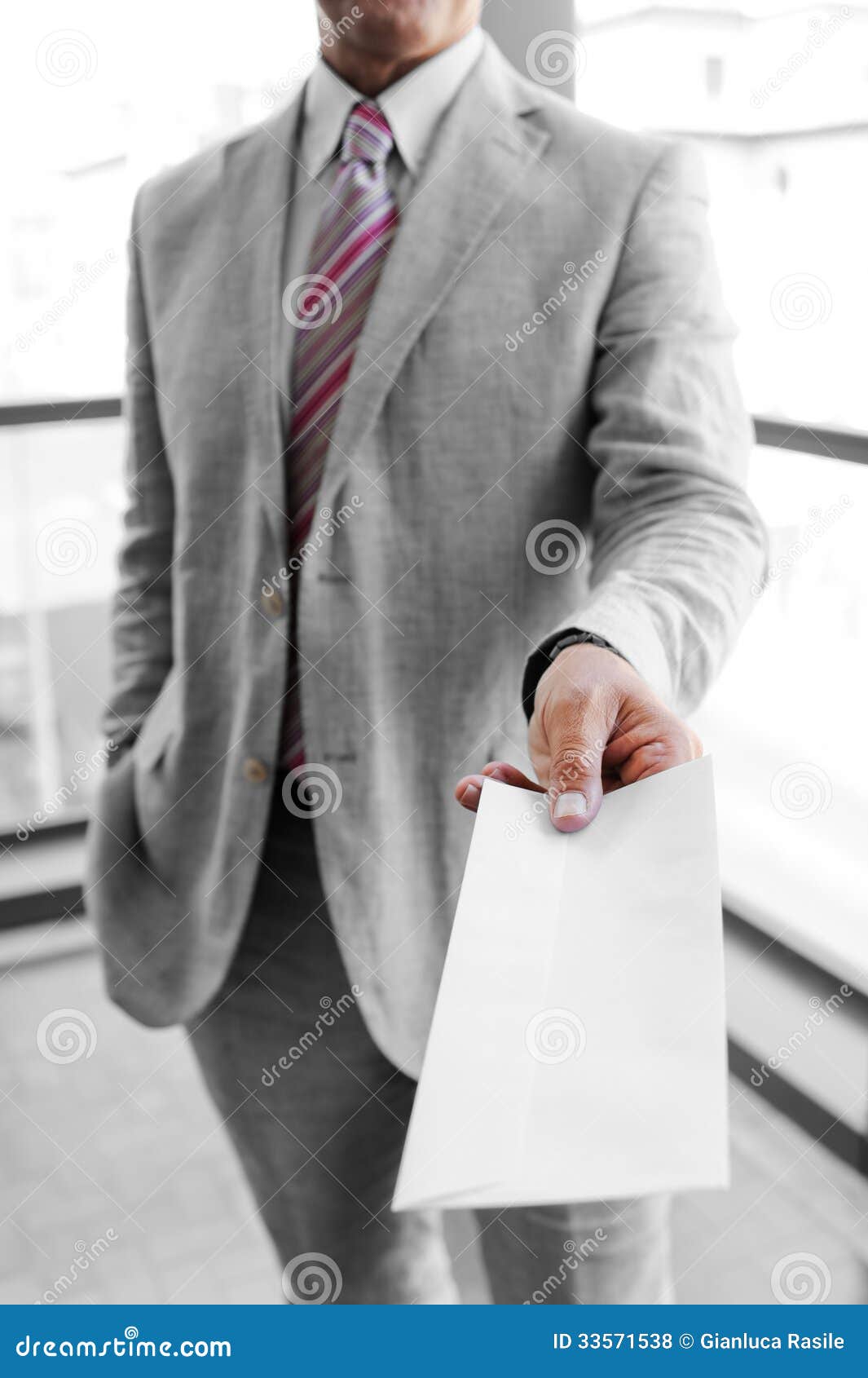 Businessman Handing a Mailing Envelope Stock Photo - Image of blurred ...