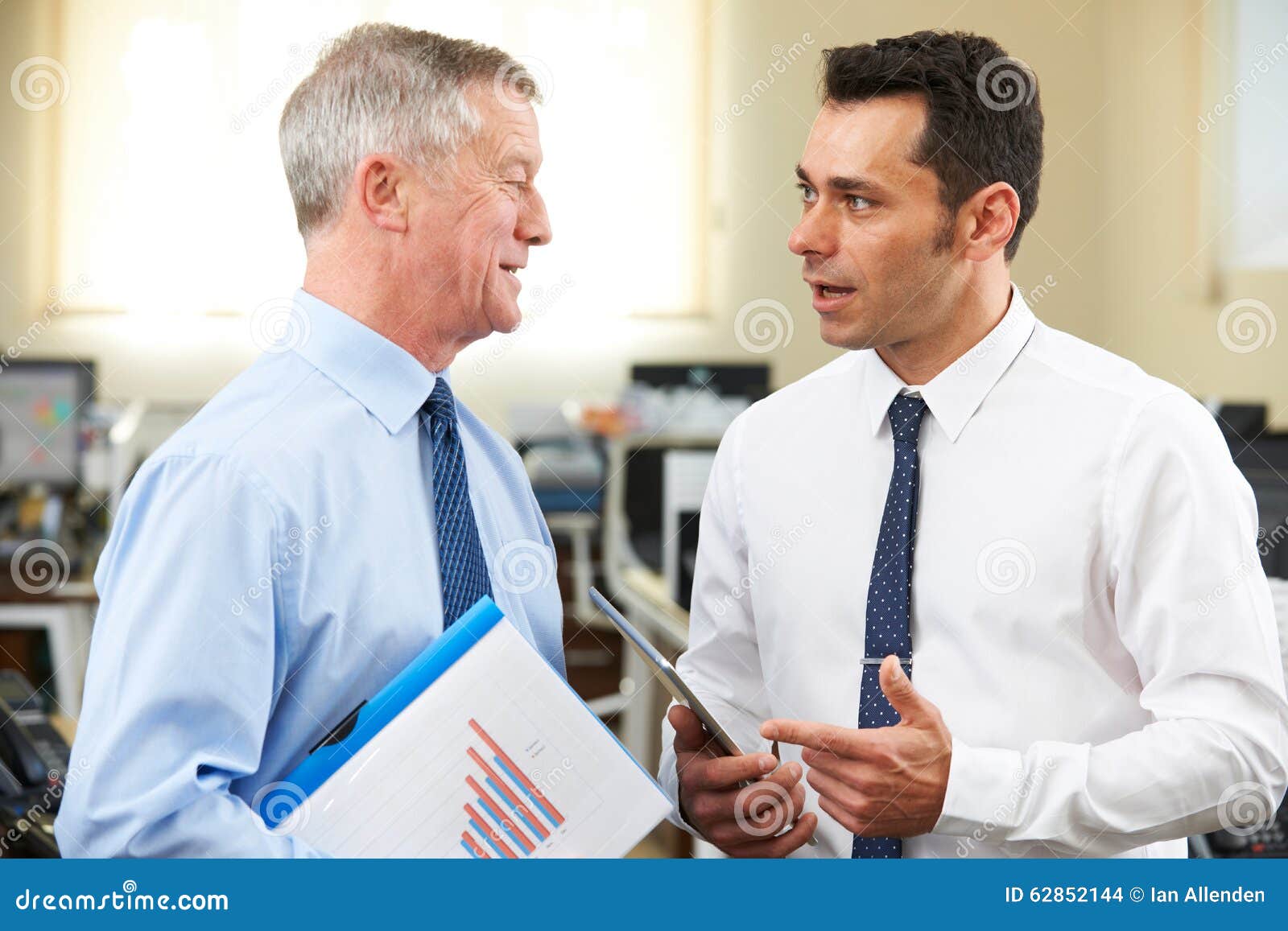 Businessman Having Discussion with Senior Mentor in Office Stock Photo ...