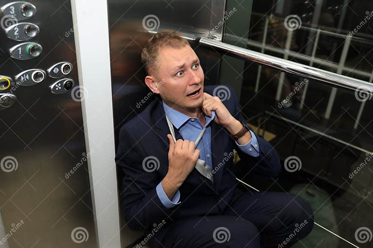 Businessman Having Panic Attack in Elevator Stock Image - Image of ...