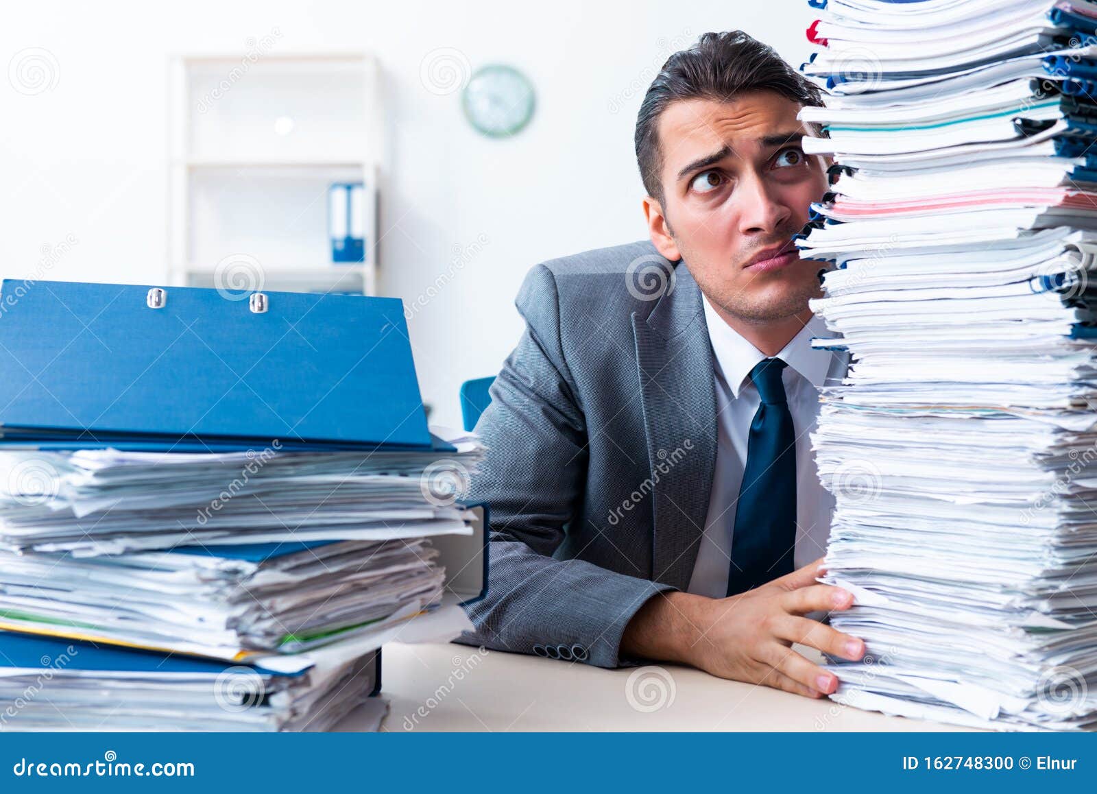 Businessman with Heavy Paperwork Workload Stock Photo - Image of paper ...