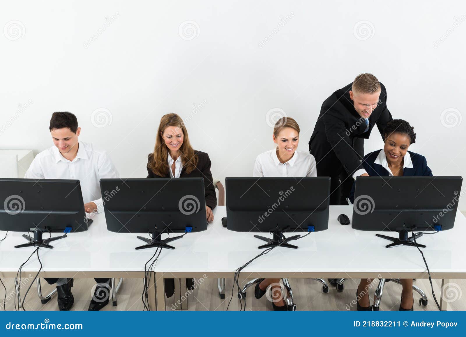 Businessman Helping His Colleagues in the Office Stock Image - Image of ...