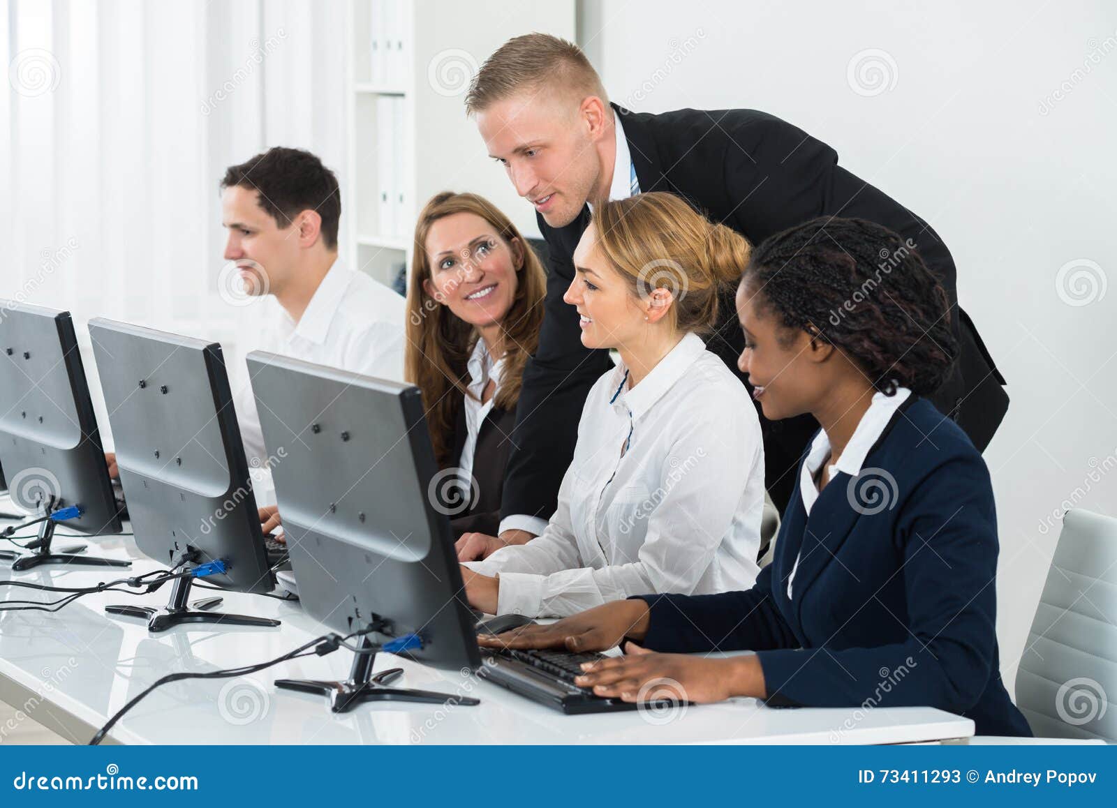 Businessman Helping His Colleagues in the Office Stock Image - Image of ...