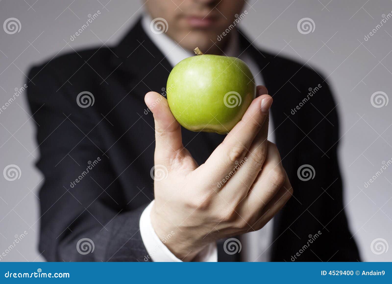 Businessman holding apple stock photo. Image of natural - 4529400