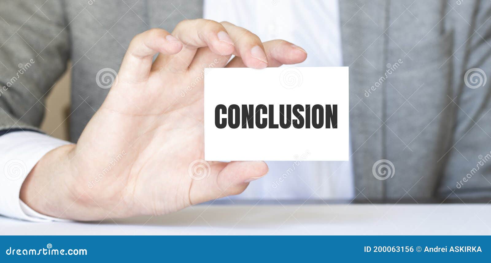 Businessman Holding a Card with Text CONCLUSION. Business Concept Stock ...