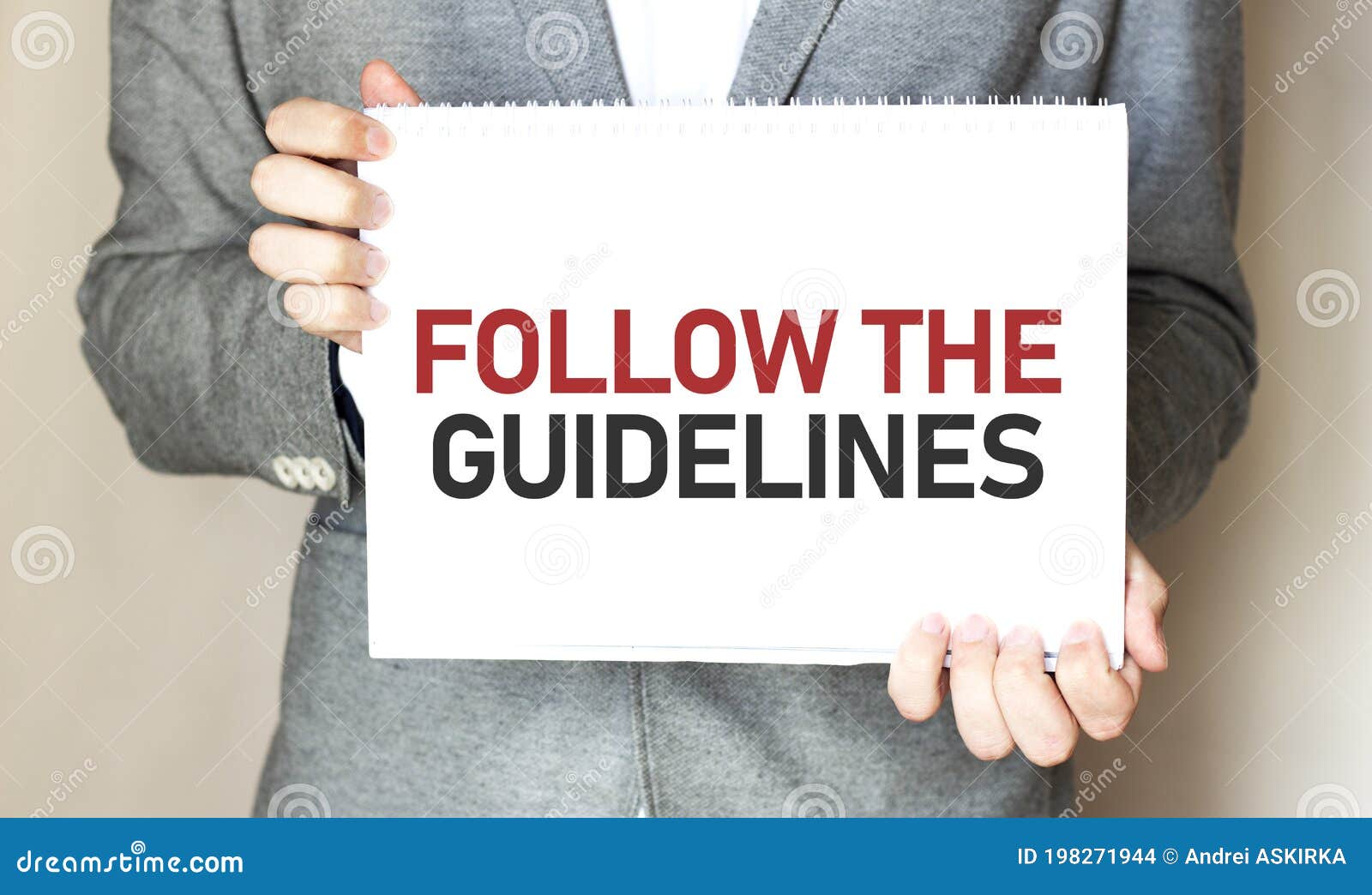 Businessman Holding a Card with Text FOLLOW the GUIDELINES Stock Photo ...